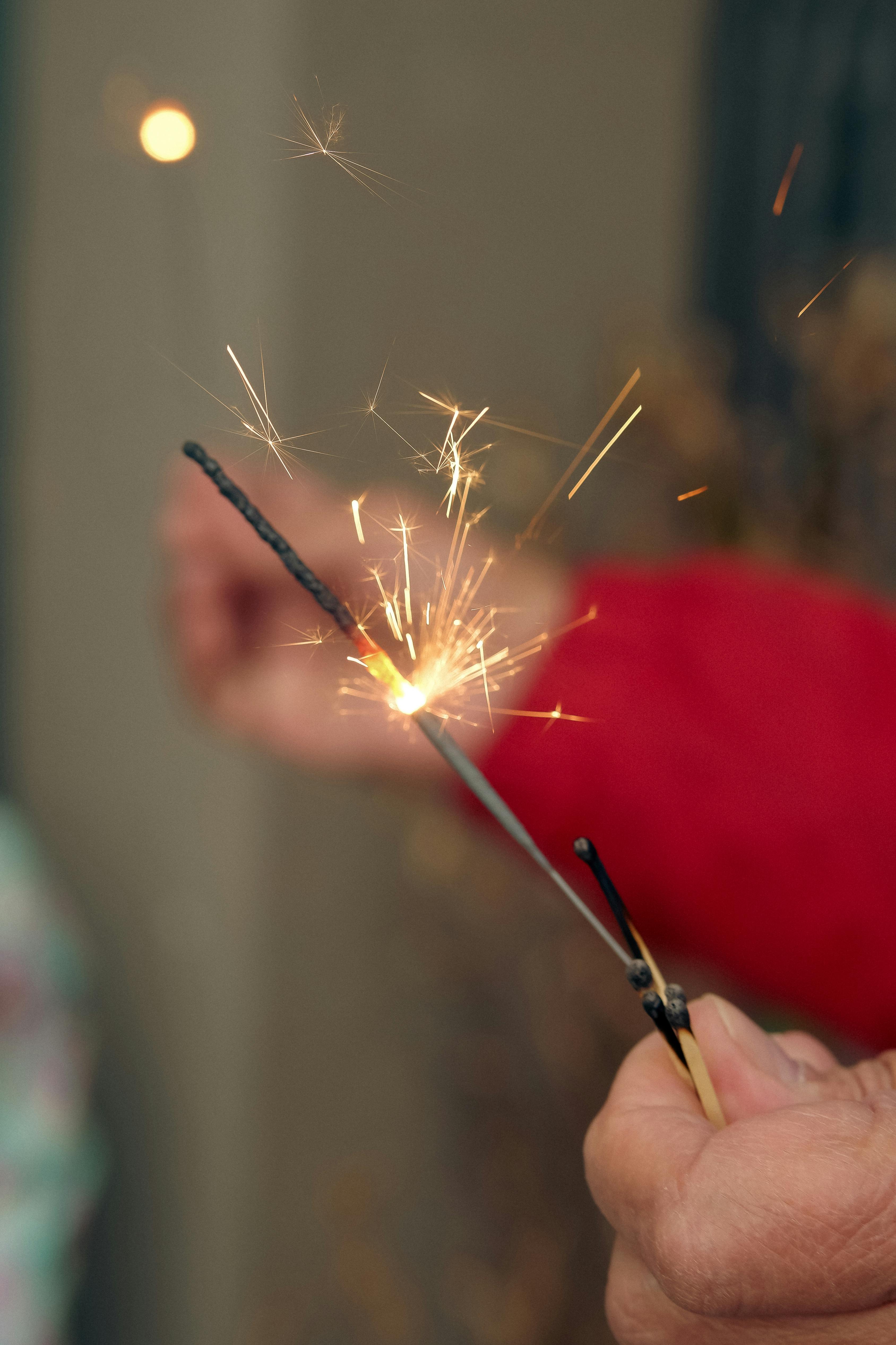 Hand Holding Sparkler in Winter · Free Stock Photo