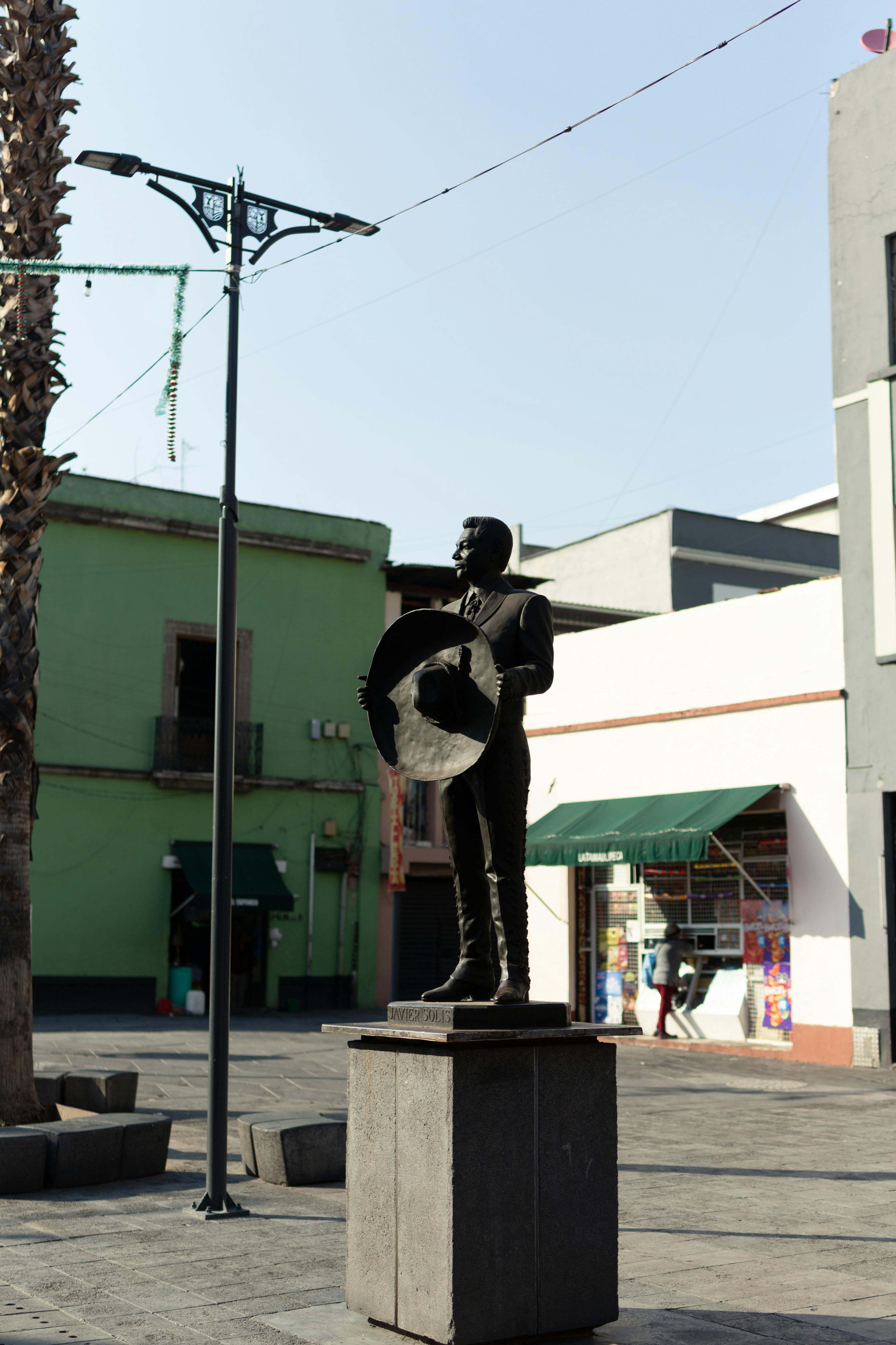 A Man Standing Near the Statue · Free Stock Photo