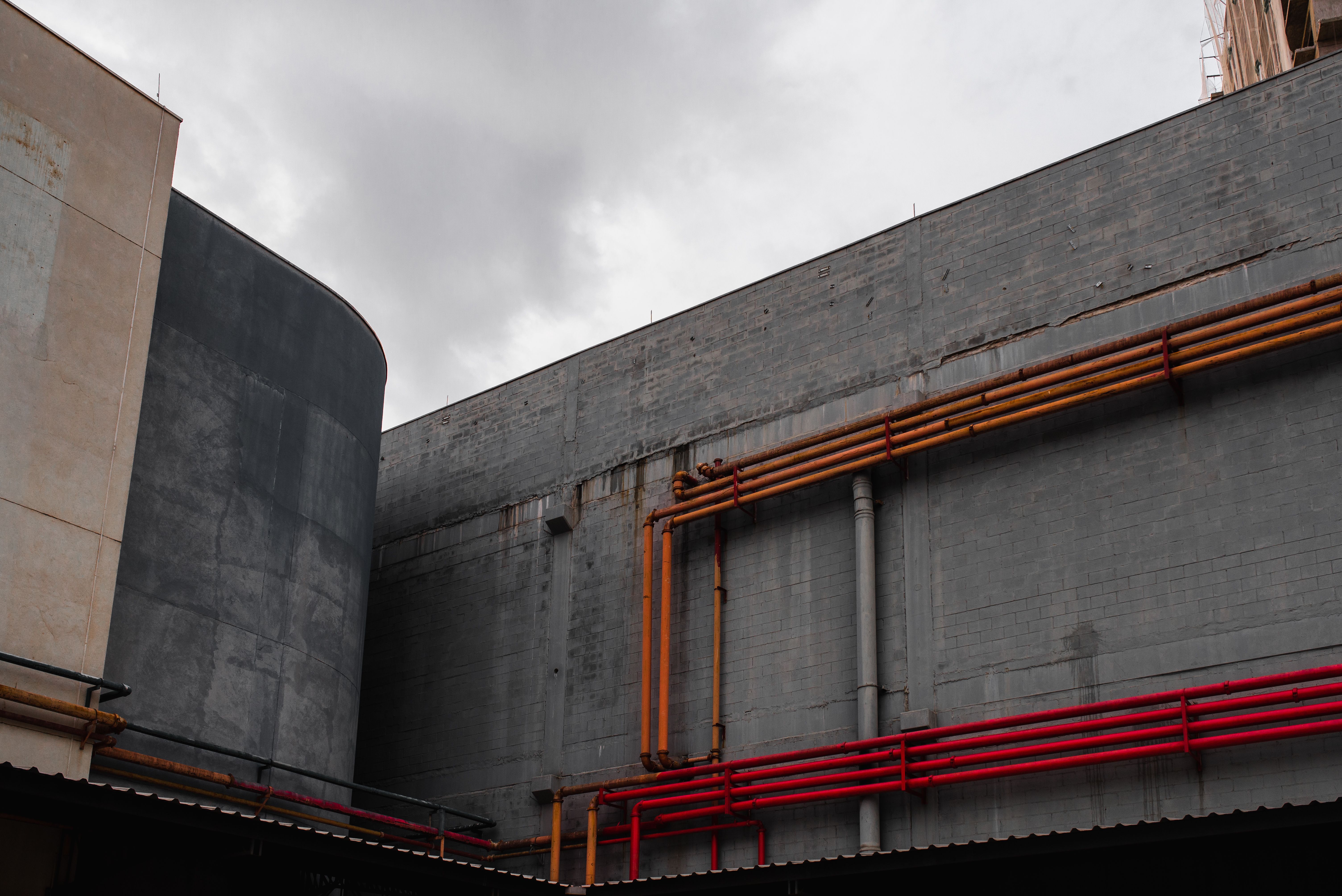 Pipes on Building Wall · Free Stock Photo