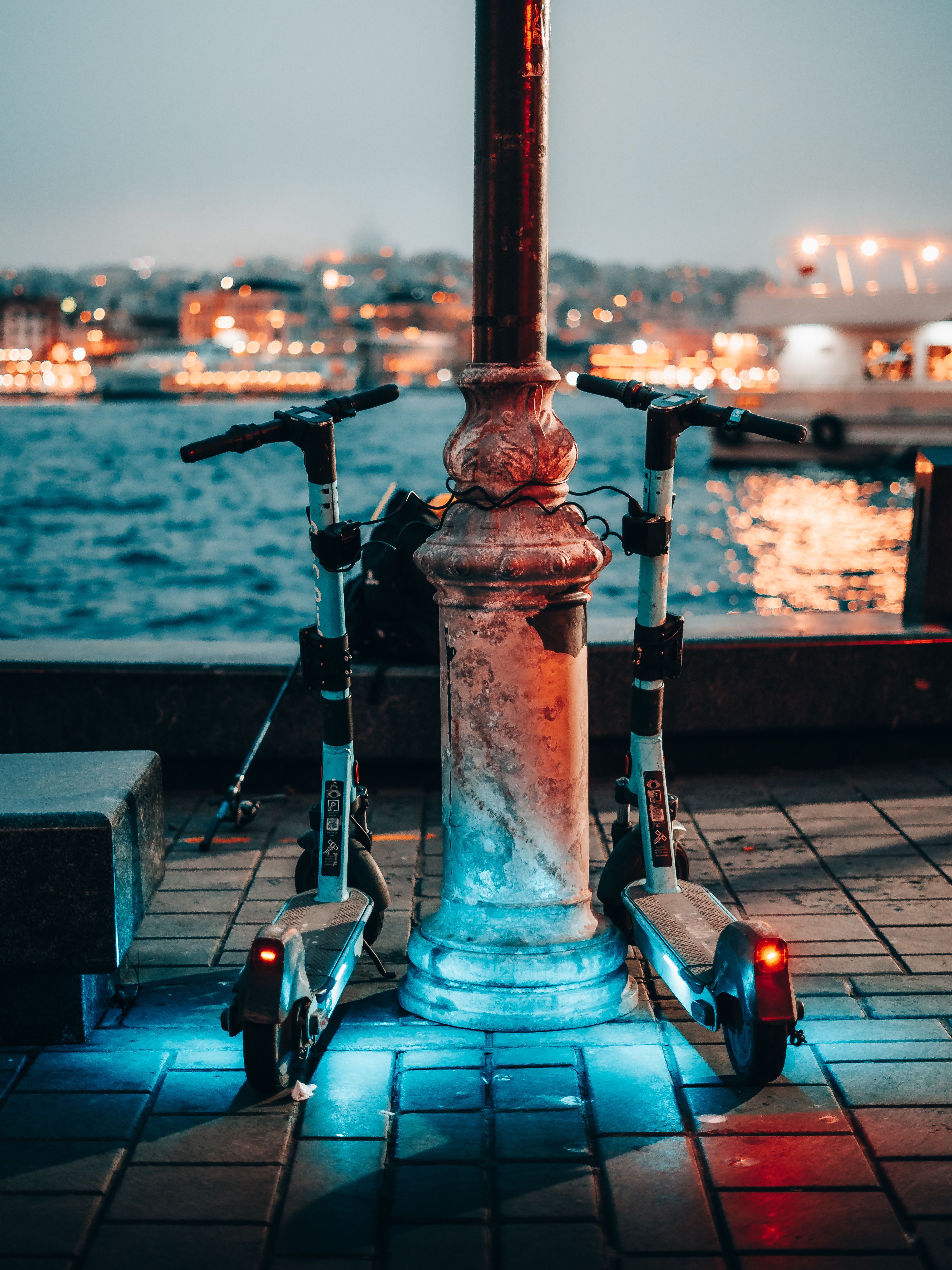 Electric Scooters by Pole on Promenade · Free Stock Photo