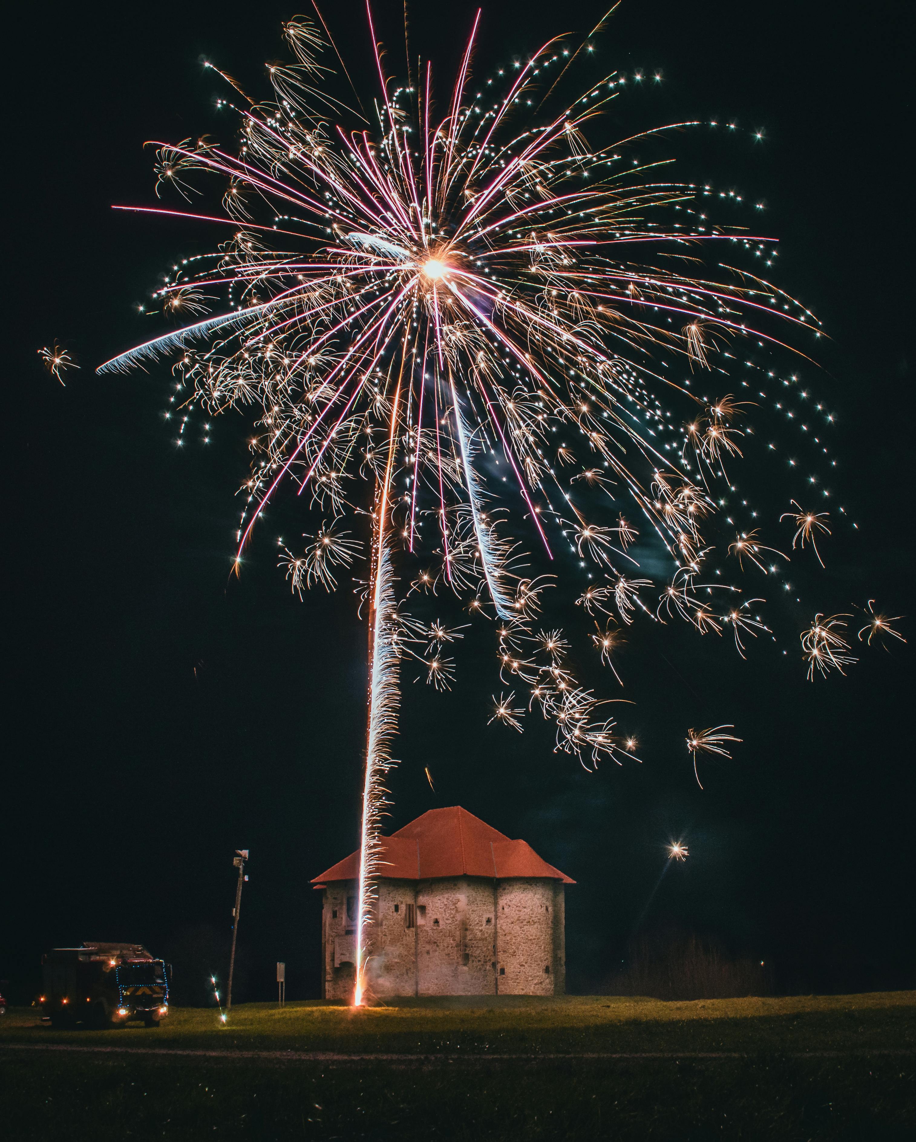 Fireworks over Building and Truck at Night · Free Stock Photo
