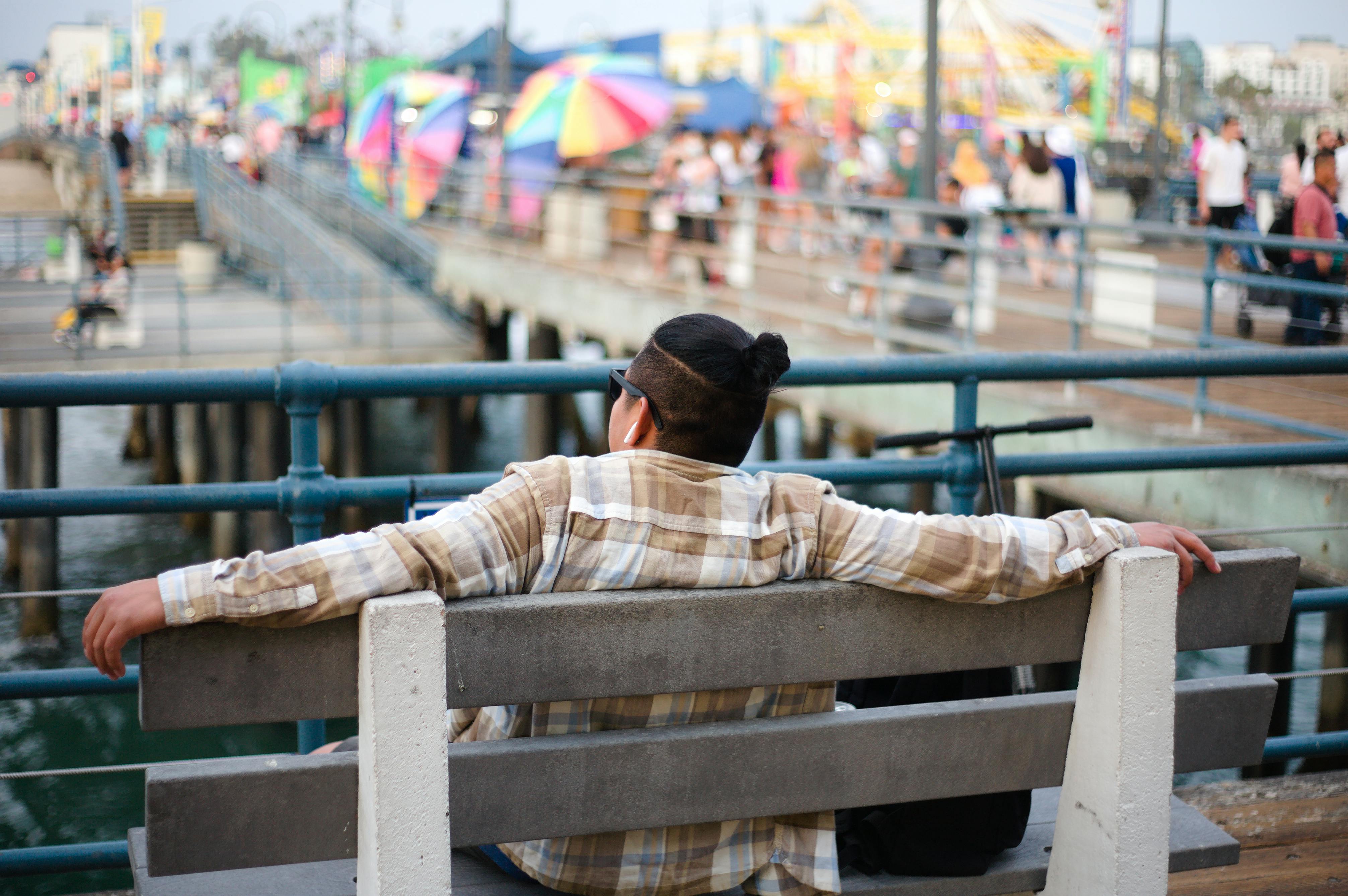 Man Sitting on Bench in Seaside · Free Stock Photo