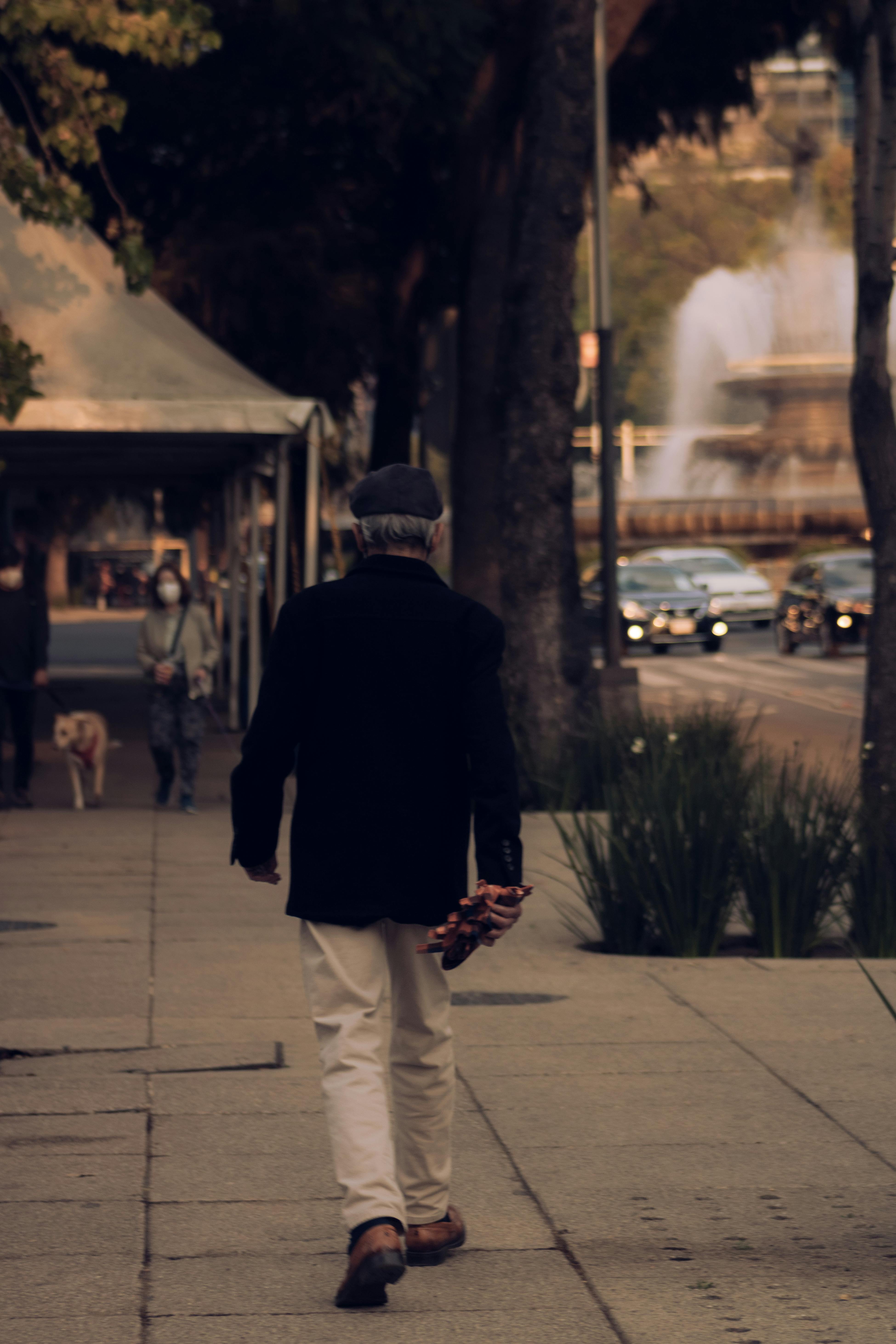 Photo of an Elderly Man in a Brown Coat Walking on a Street · Free ...