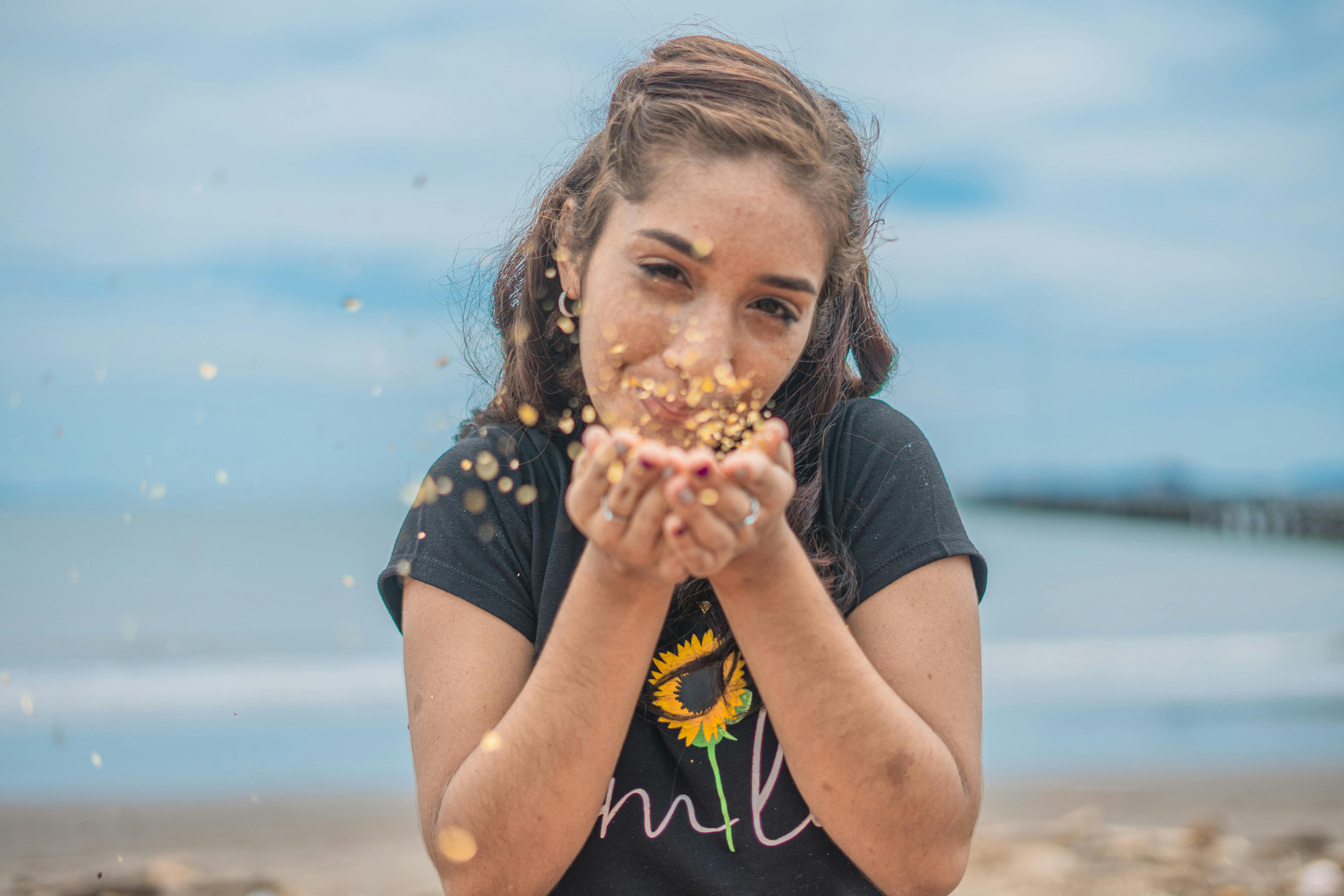 A girl is eating sand on the beach · Free Stock Photo