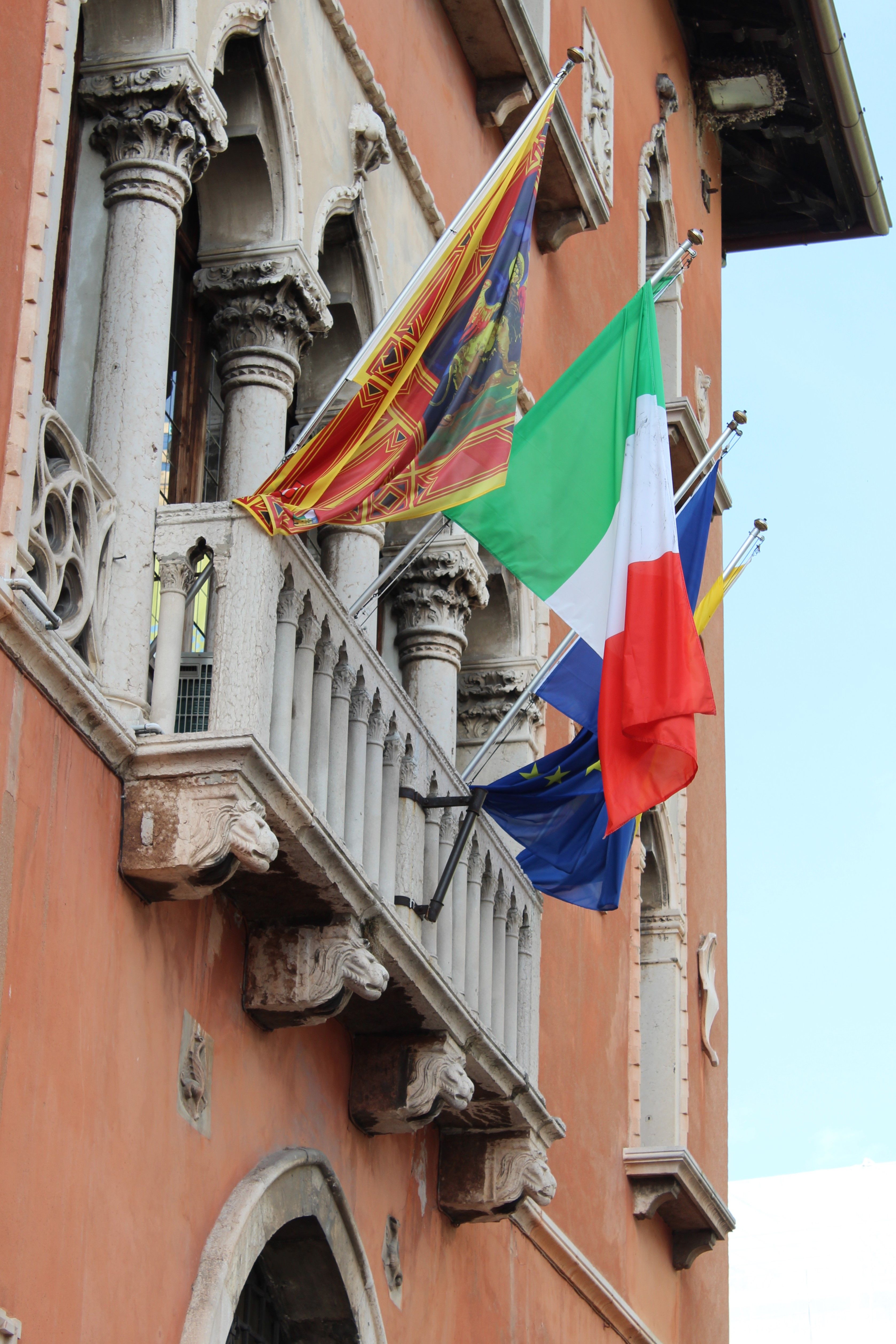 Italian and European flags on municipal building facade · Free Stock Photo