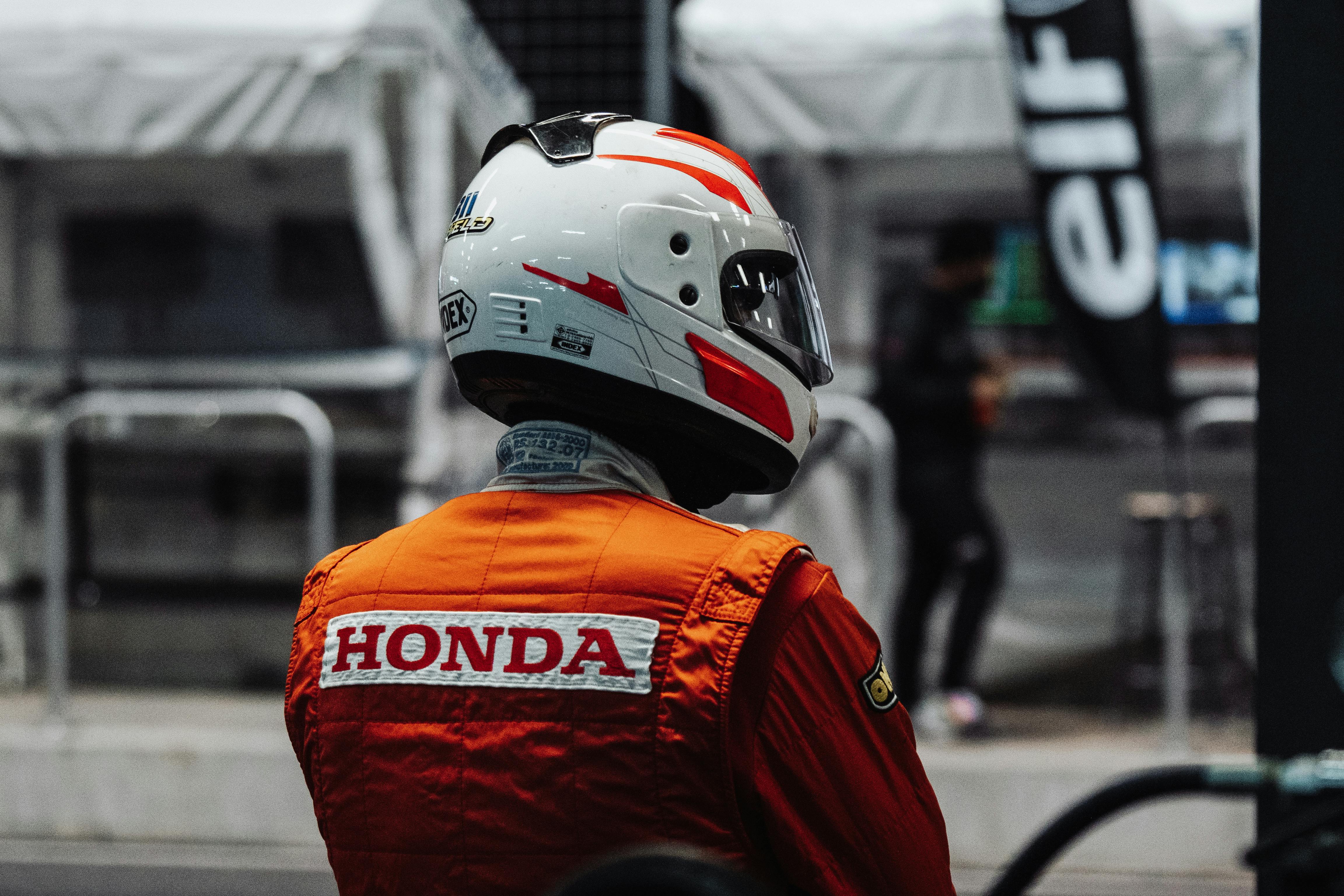 Man in Blue and and White Racer Suit Wearing His Blue and Yellow Star ...