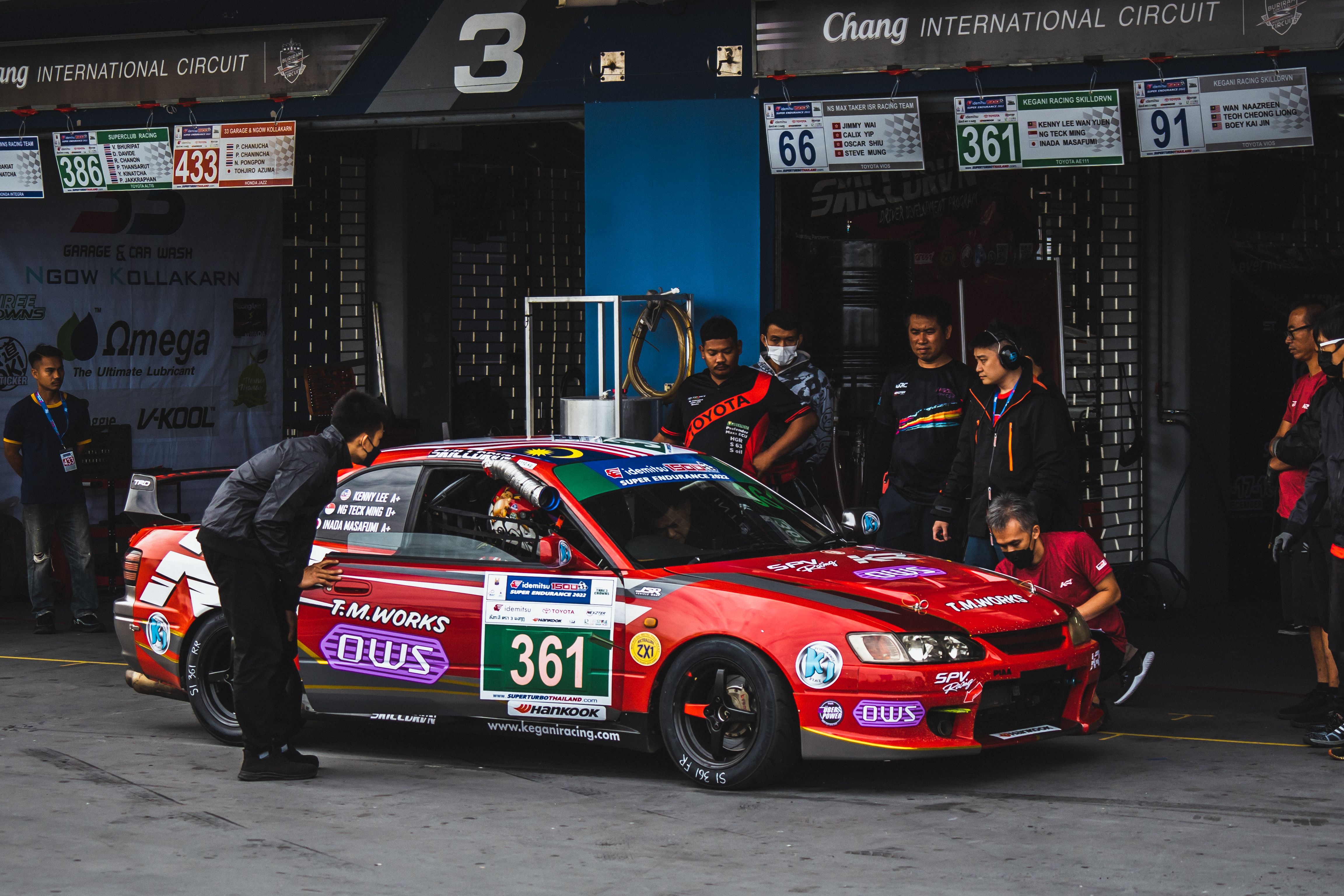 Pit Crew Pushing a Racing Car · Free Stock Photo