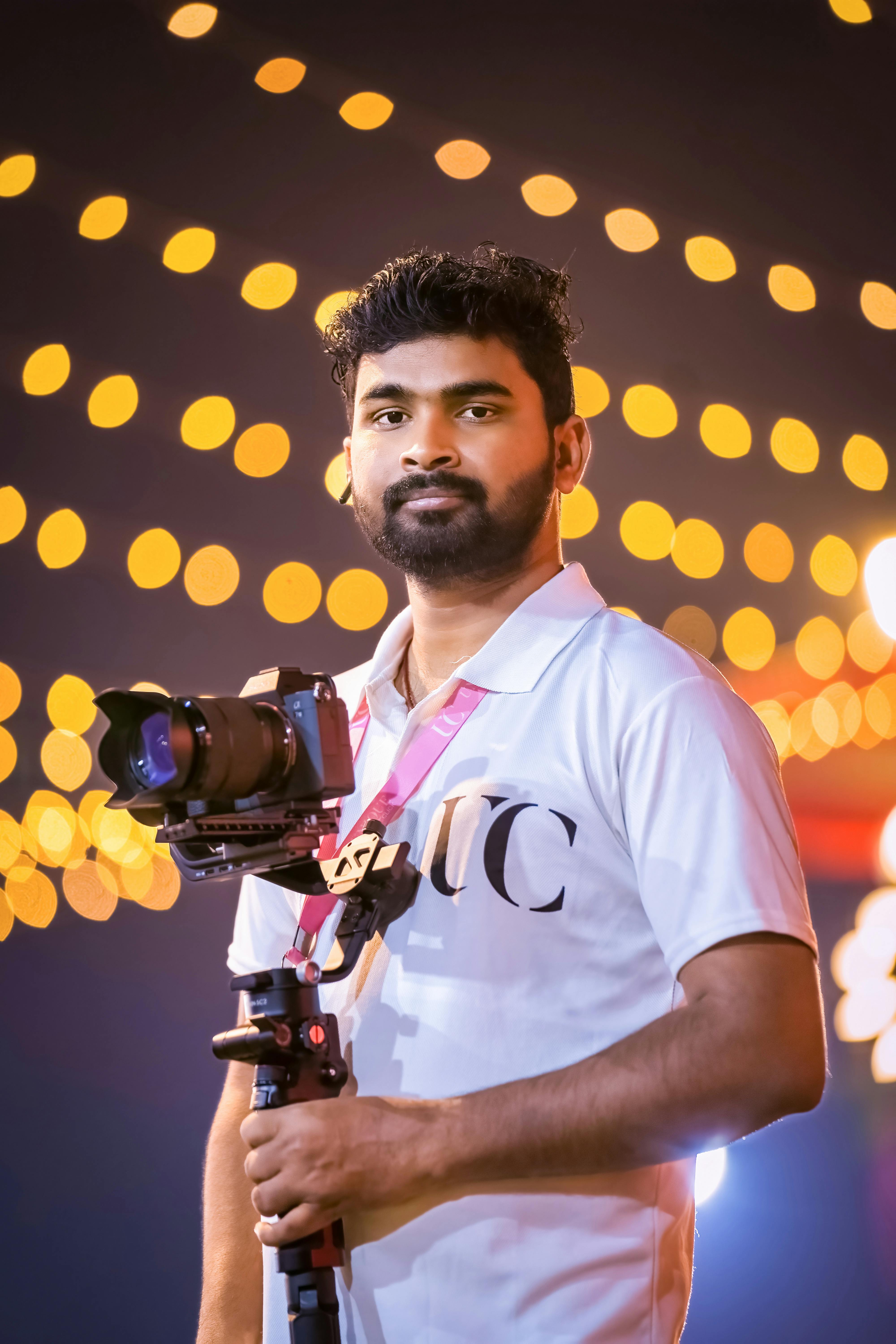 Grayscale Portrait Photo of Man Wearing Holding a Camera · Free Stock Photo