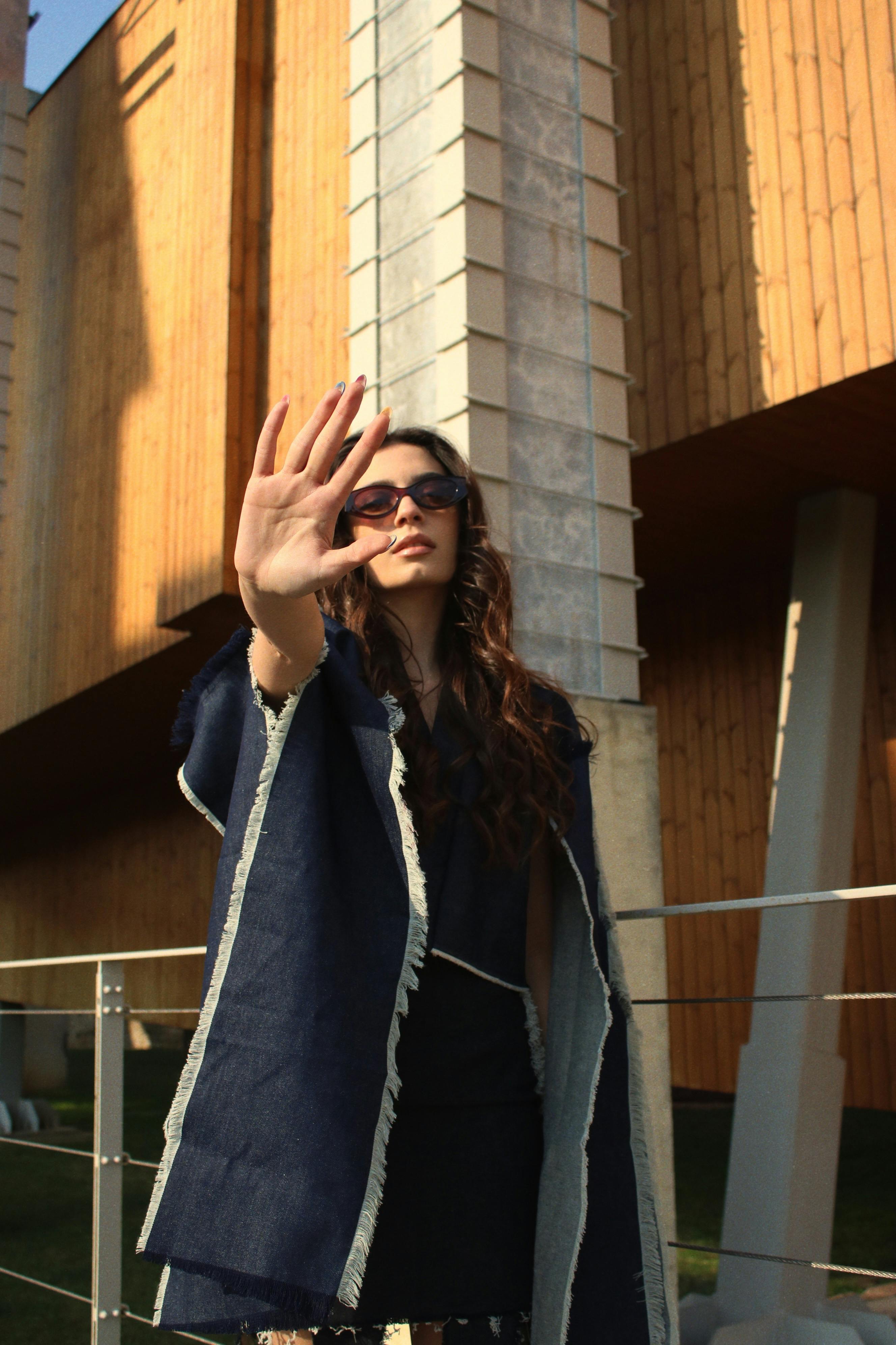 Woman in Vest Posing with Hand Stretched · Free Stock Photo