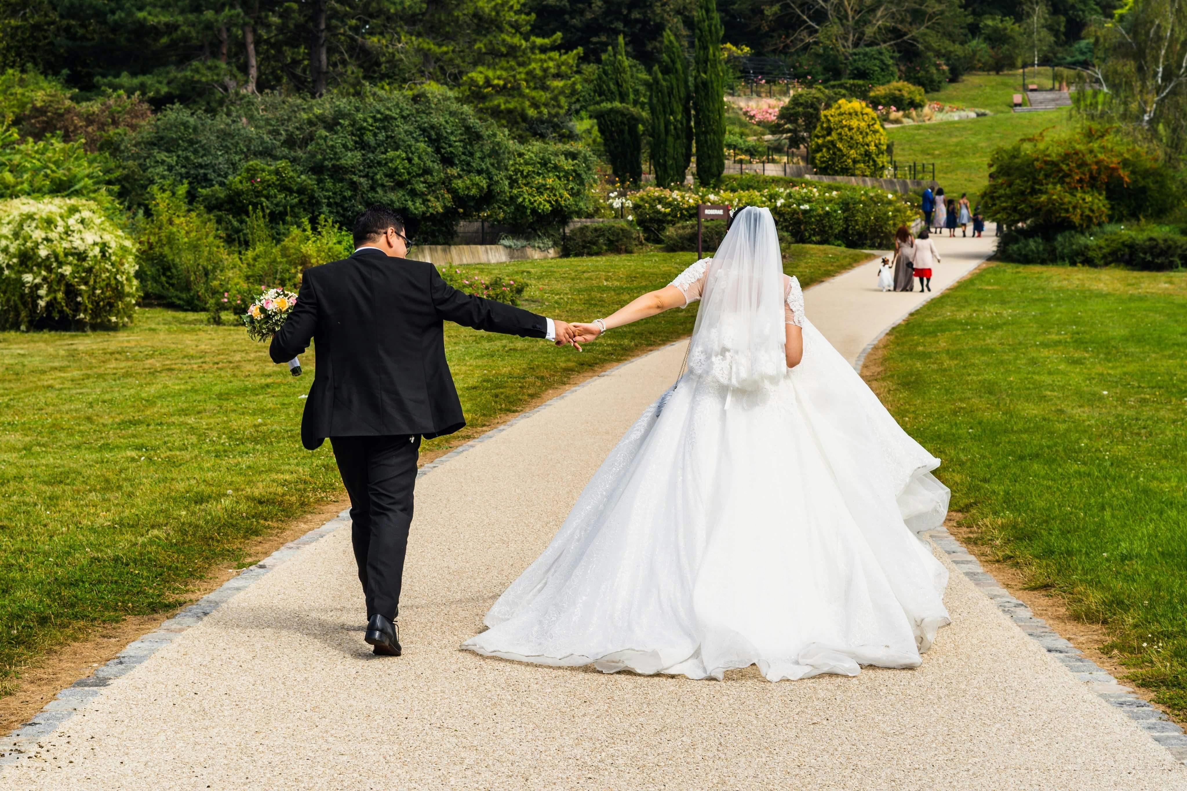 Back View of a Married Couple Walking in a Park · Free Stock Photo