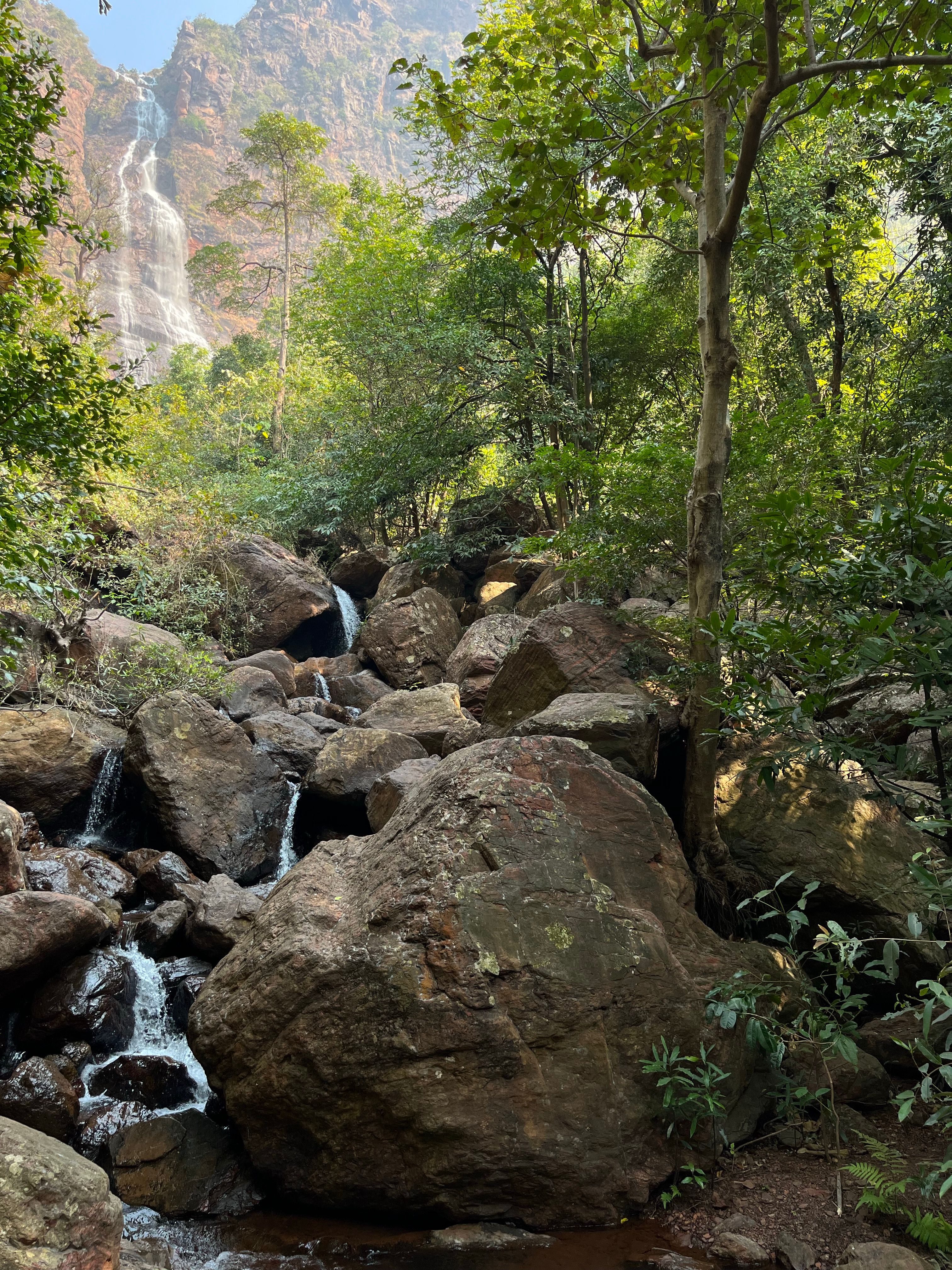 A Rocky Stream and a Waterfall in Distance · Free Stock Photo