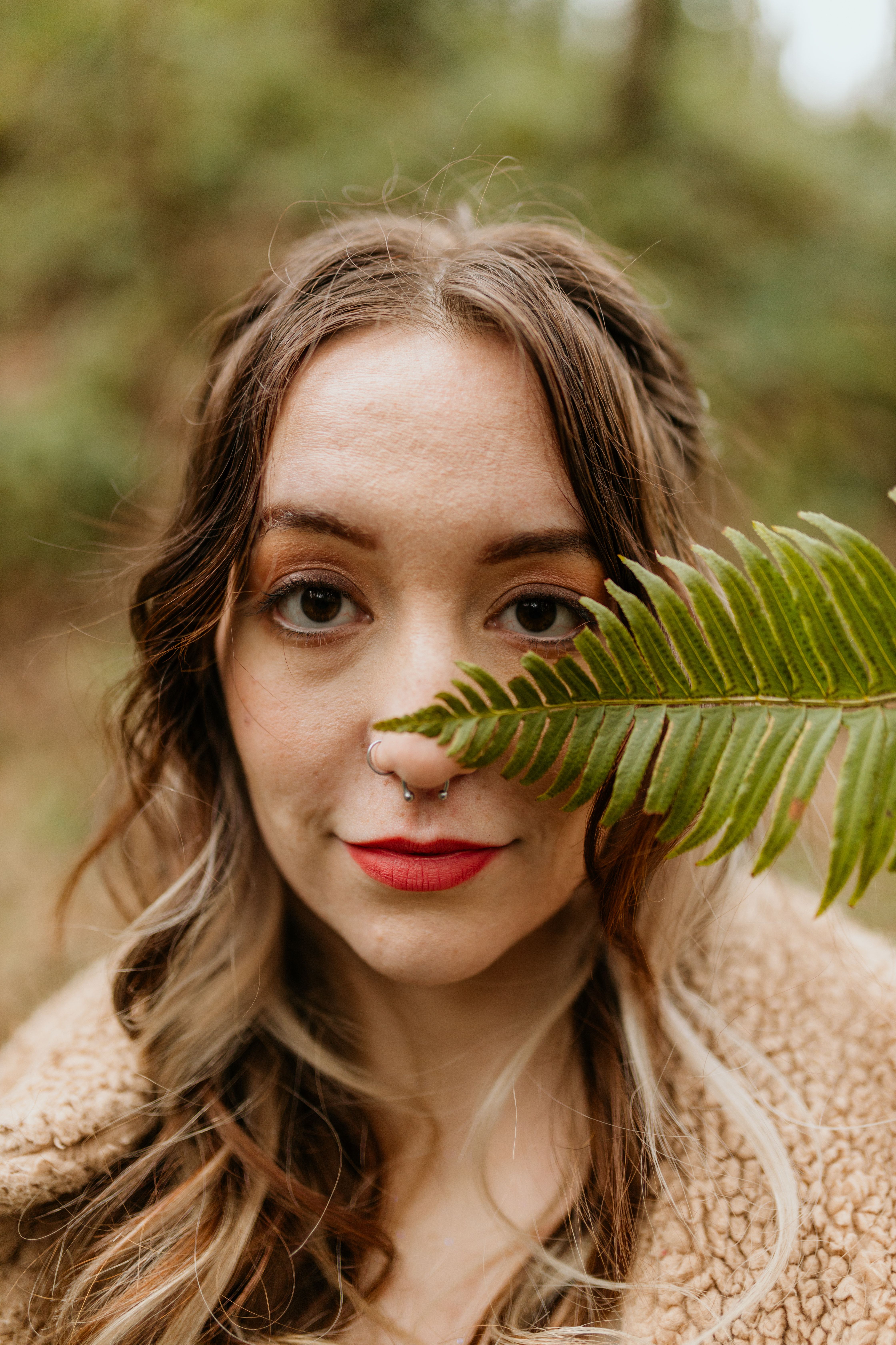 Portrait of Woman with Fern Leaf Outdoors · Free Stock Photo