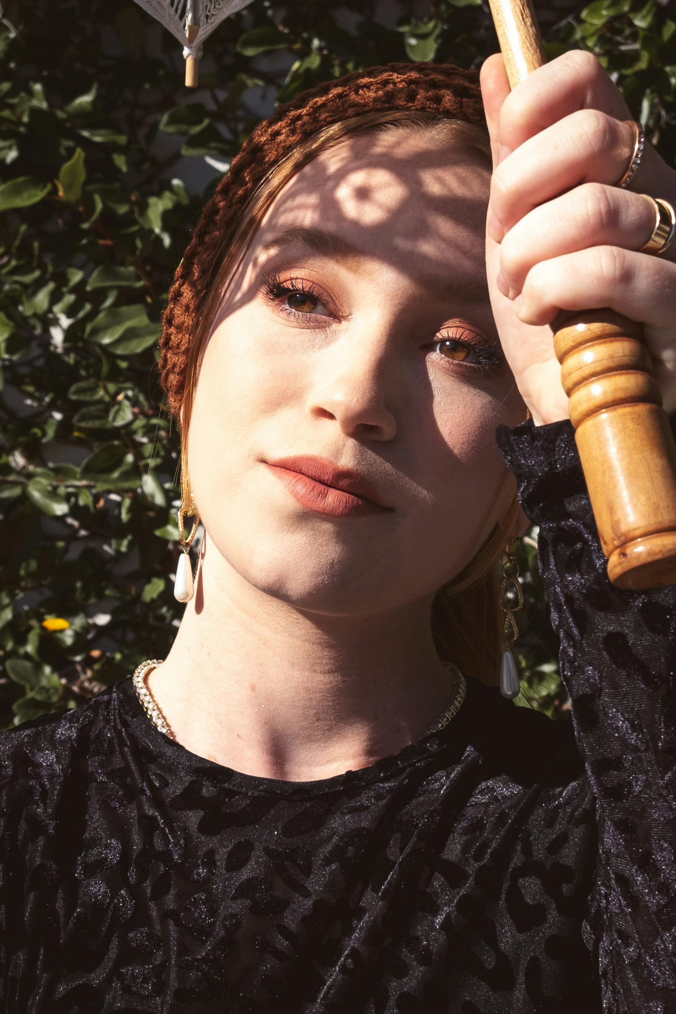Portrait of a Woman Holding an Umbrella Handle · Free Stock Photo