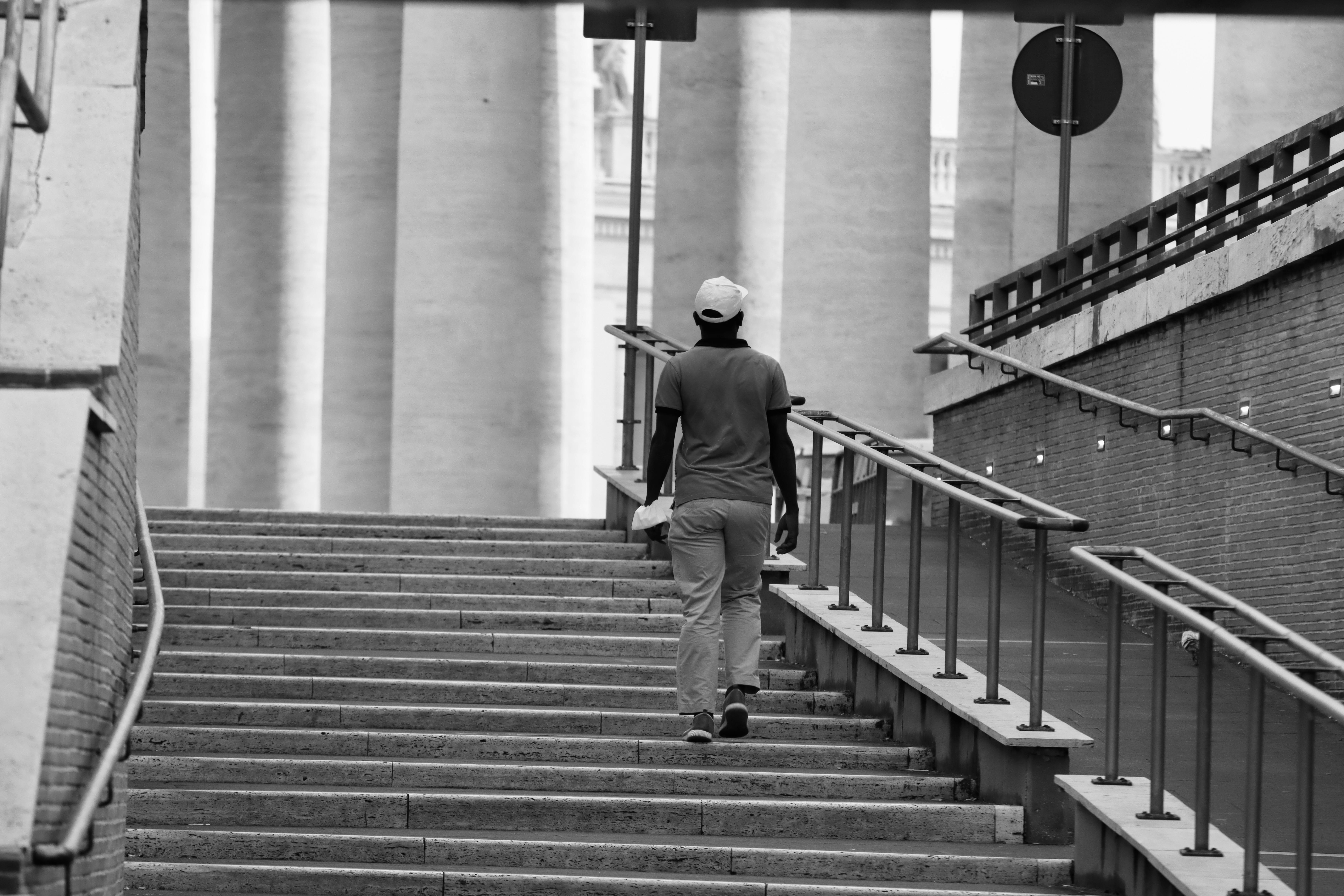 Man Walking on Gray Stairs · Free Stock Photo