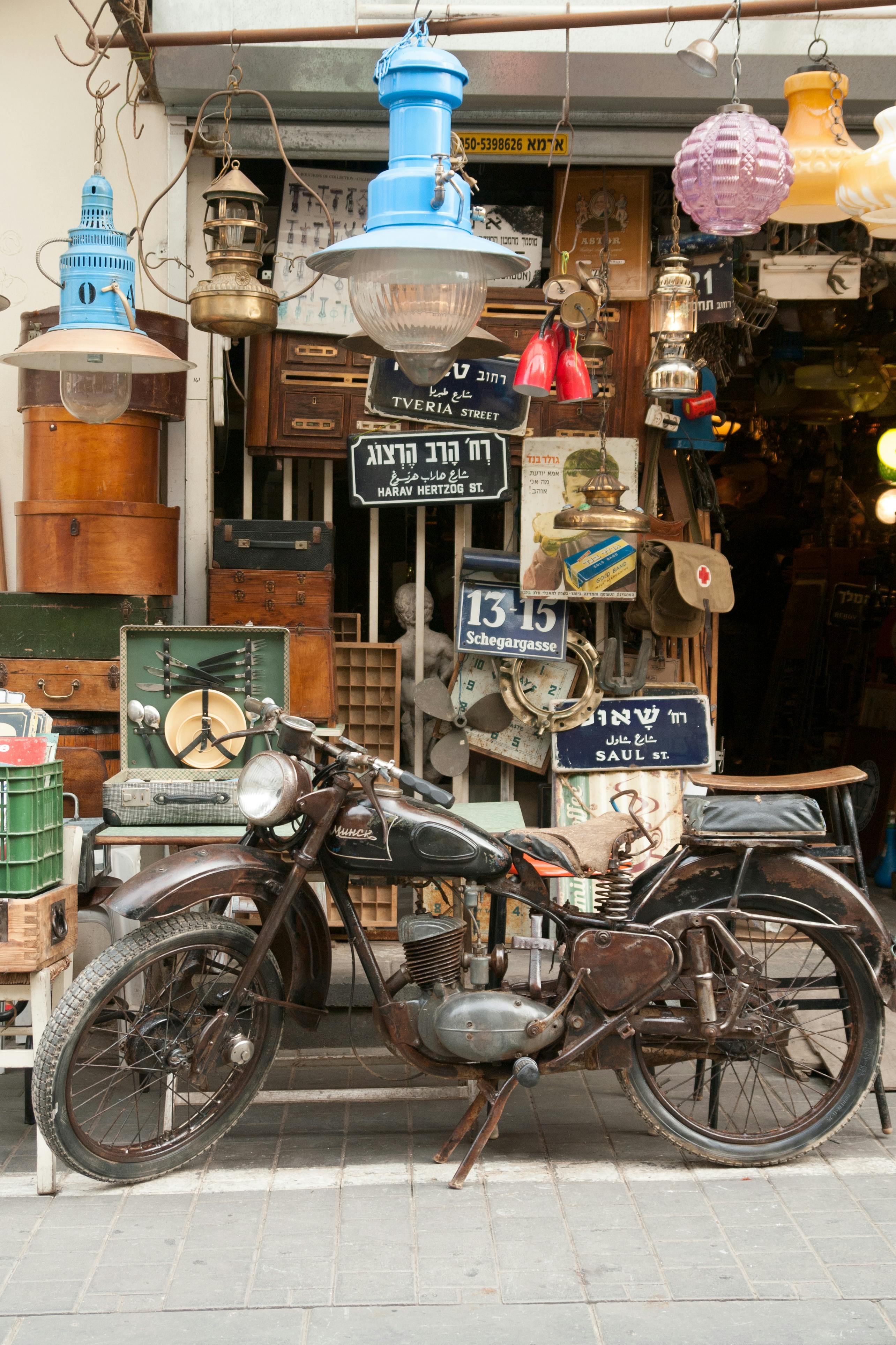 A Vintage Motorcycle Parked in front of a Shop with Antiques · Free ...