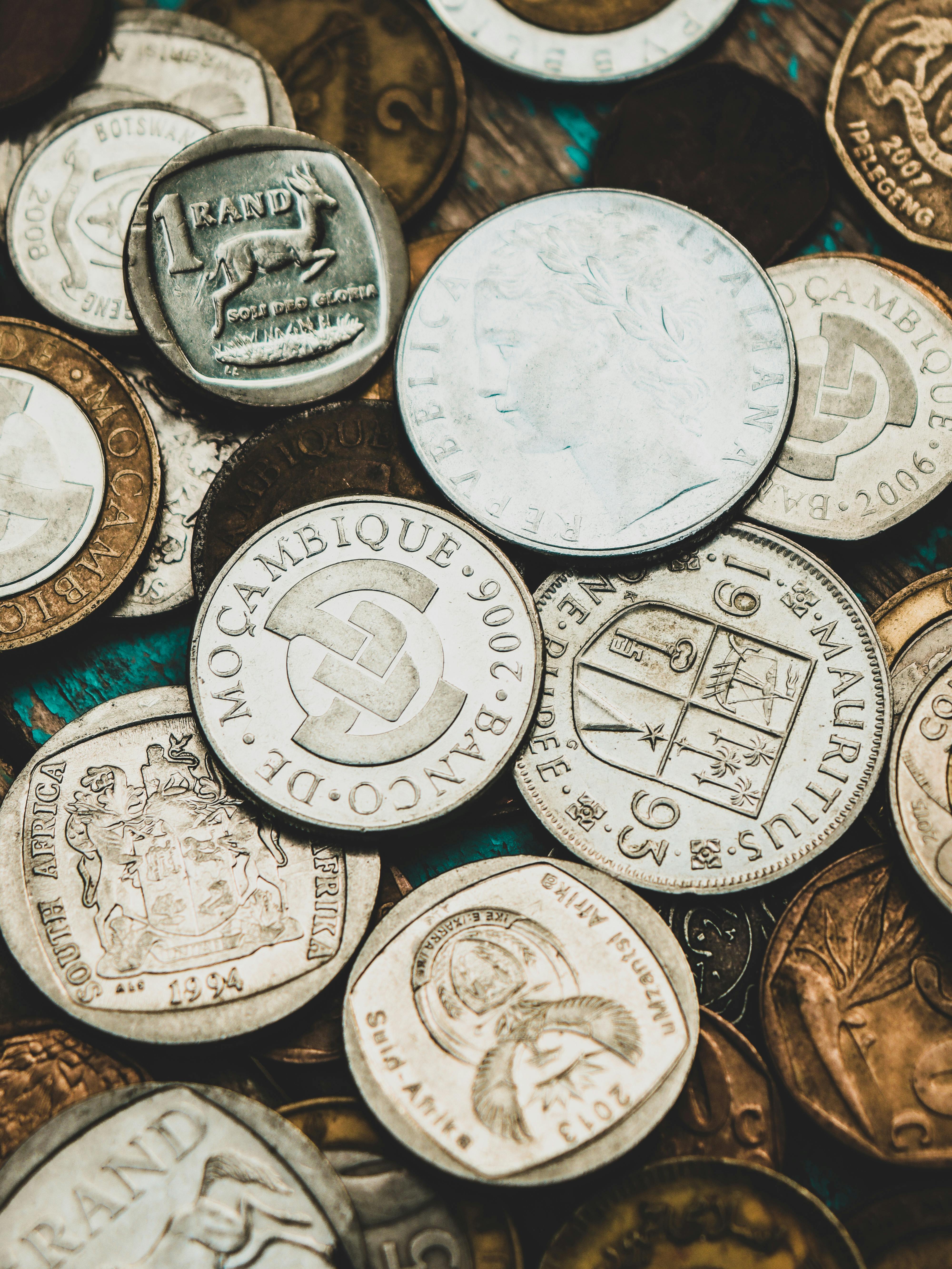 Assorted Silver-and-gold-colored Coins on Gray Surface · Free Stock Photo