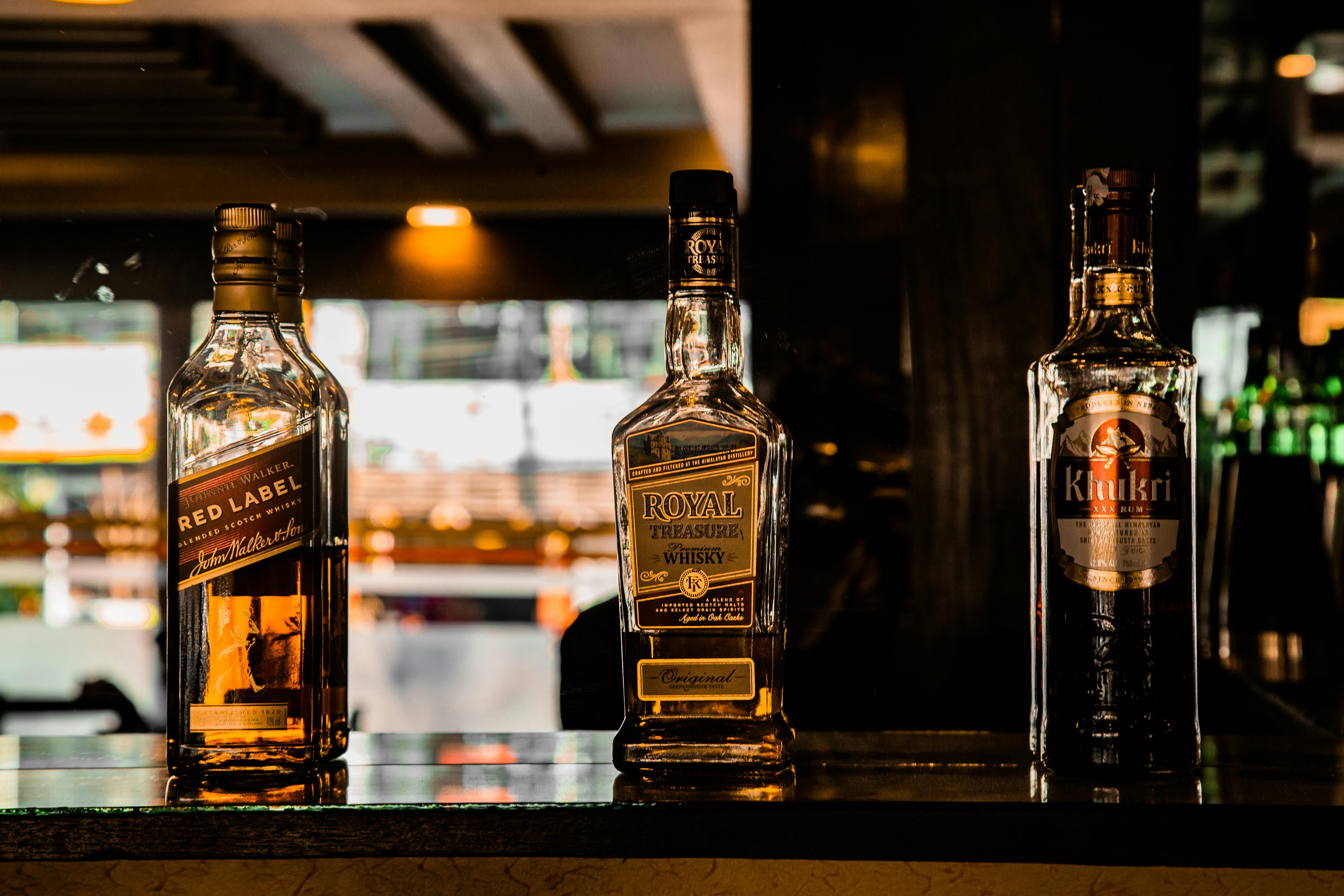 Selective Focus Photography of Assorted-brand Liquor Bottles · Free ...