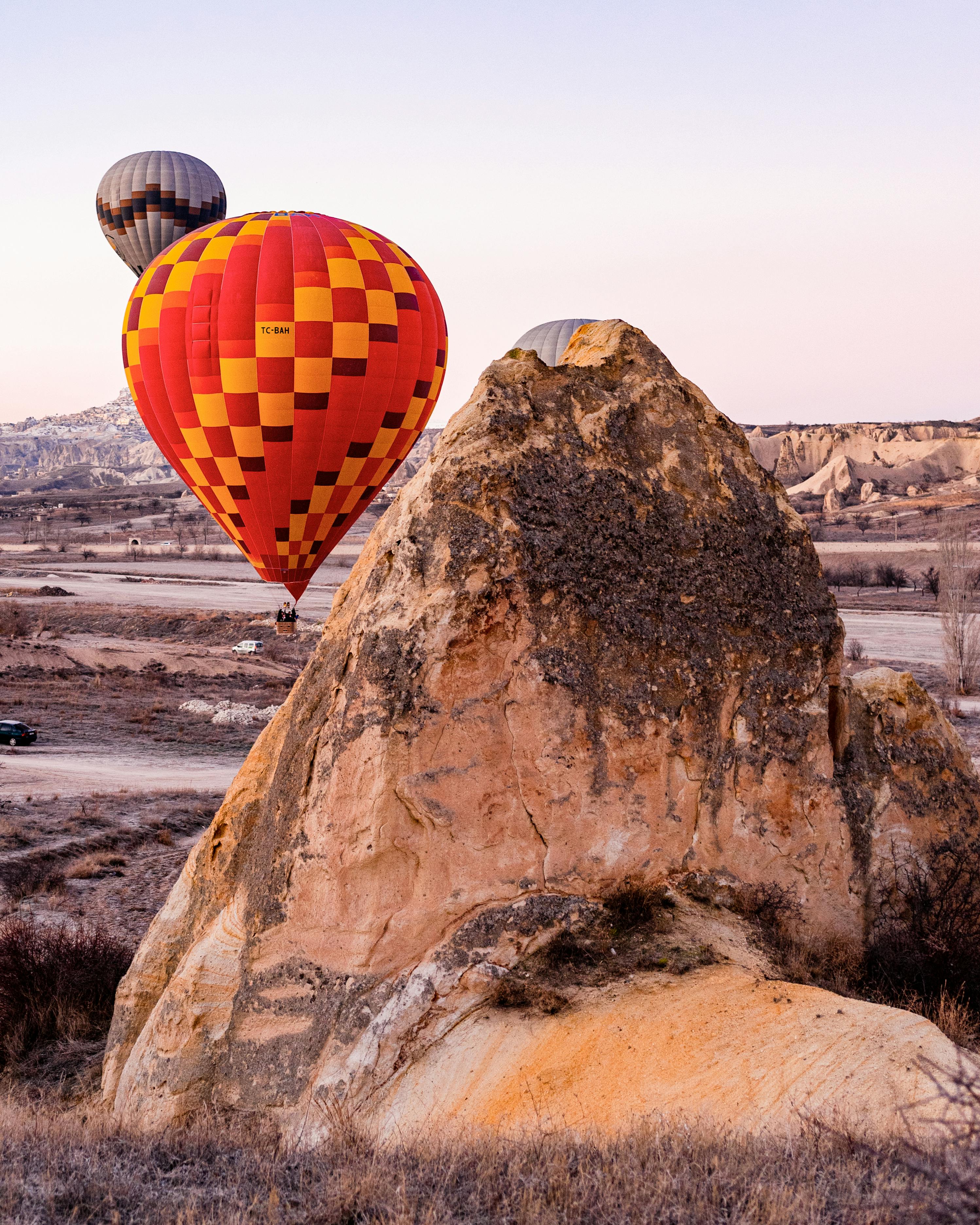 Balloons behind Rock · Free Stock Photo