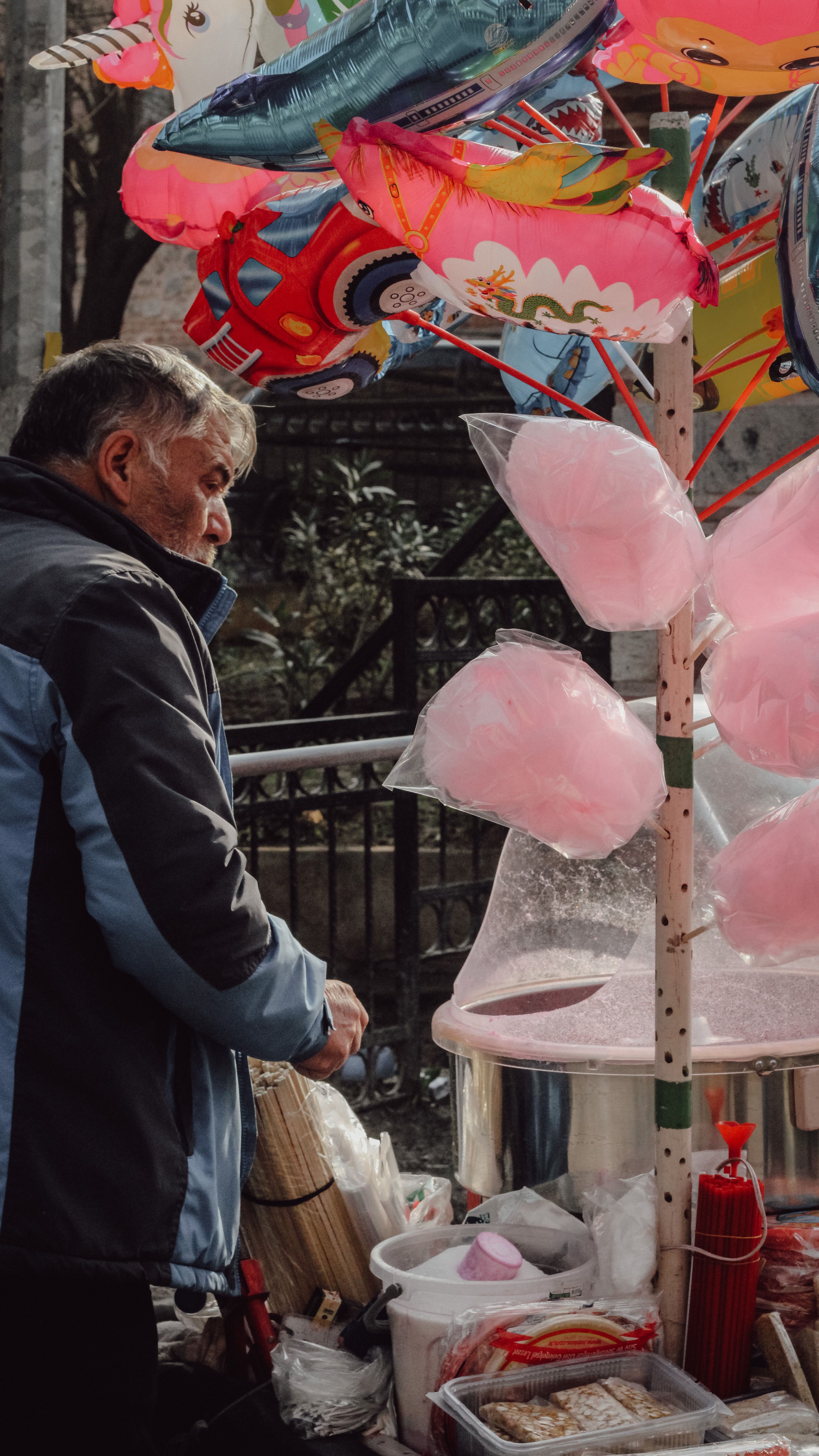 Man Working on Cotton Candy Stand · Free Stock Photo