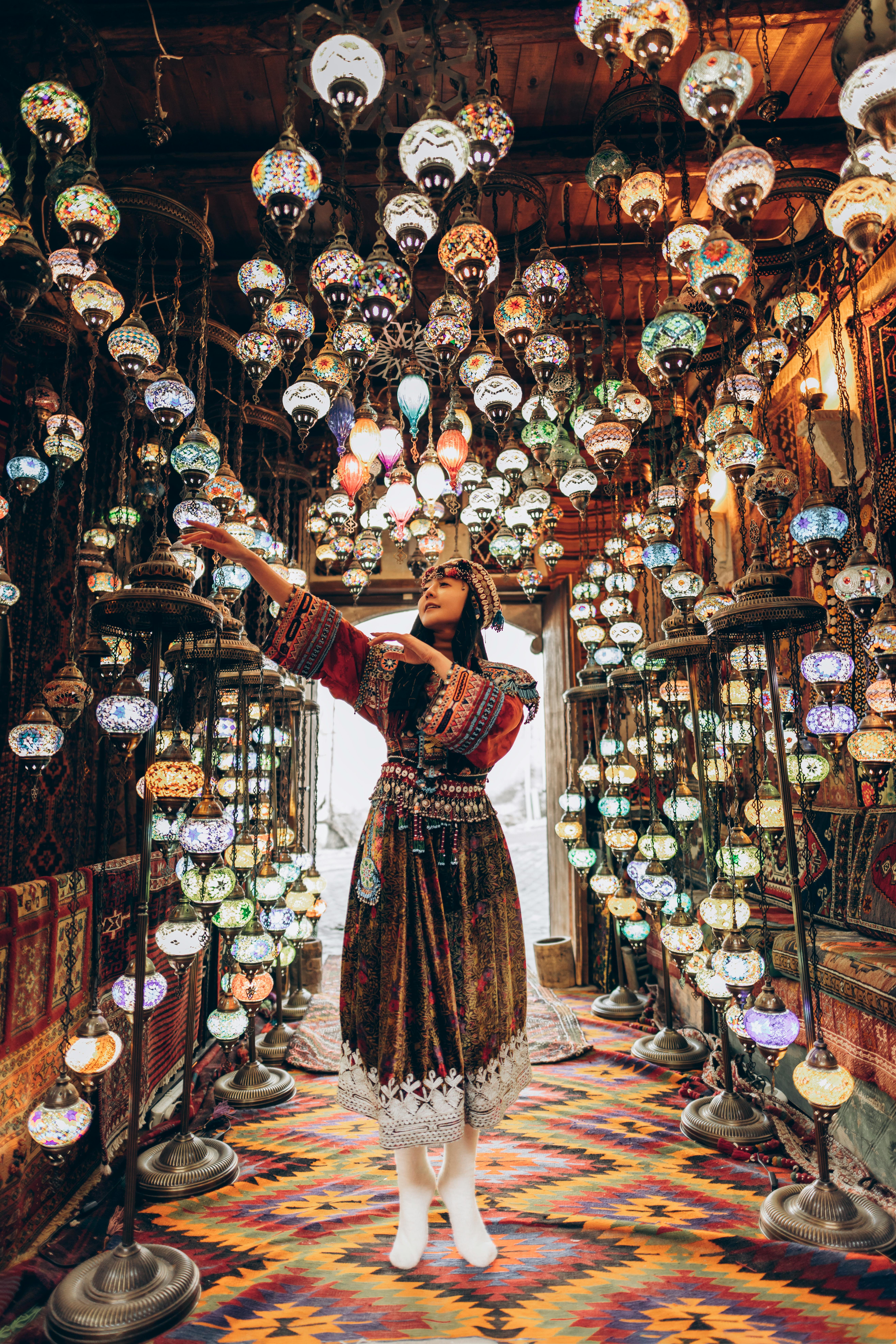 Woman in Traditional Costume in Shop with Lamps · Free Stock Photo