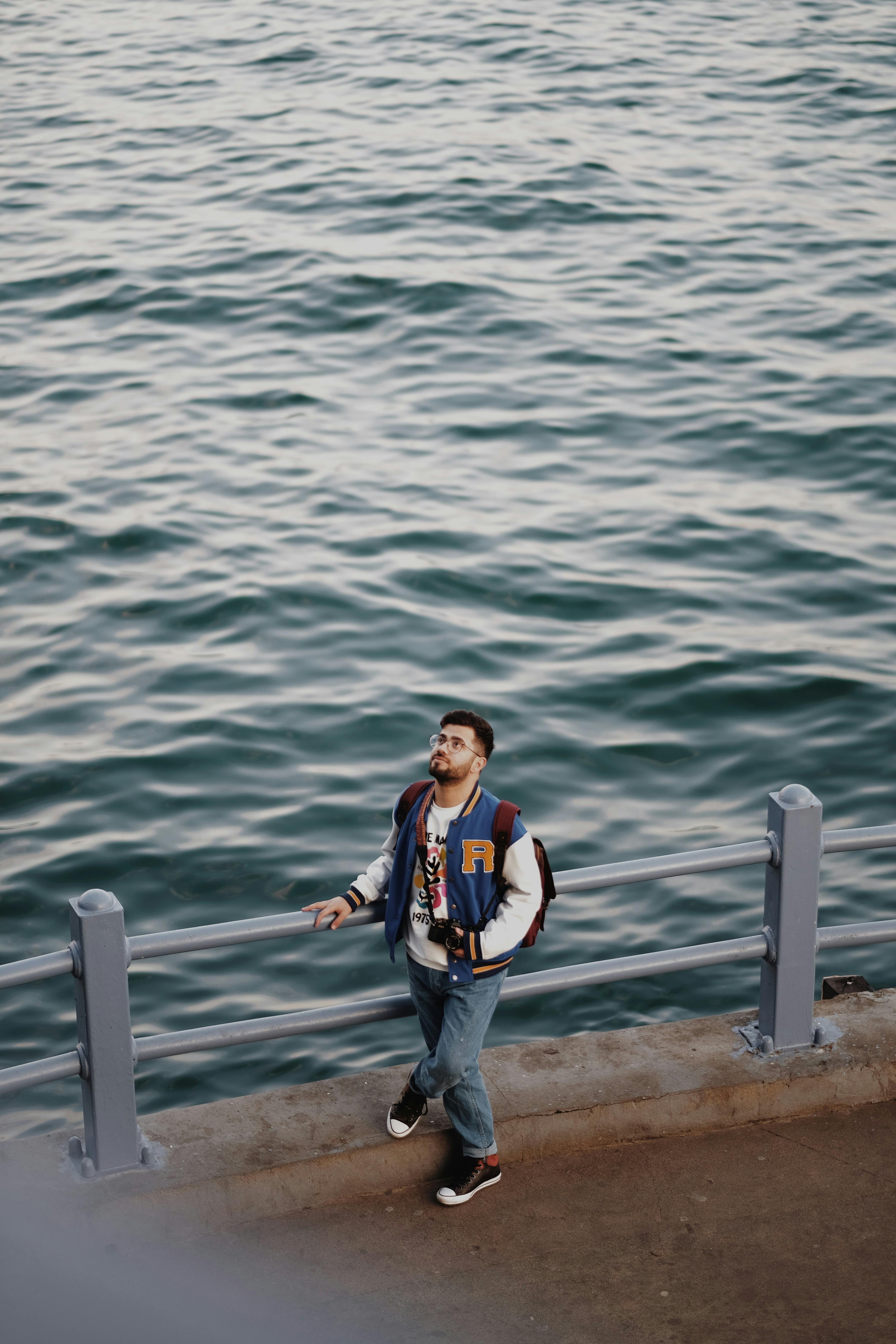 Man Looking Up on Promenade · Free Stock Photo