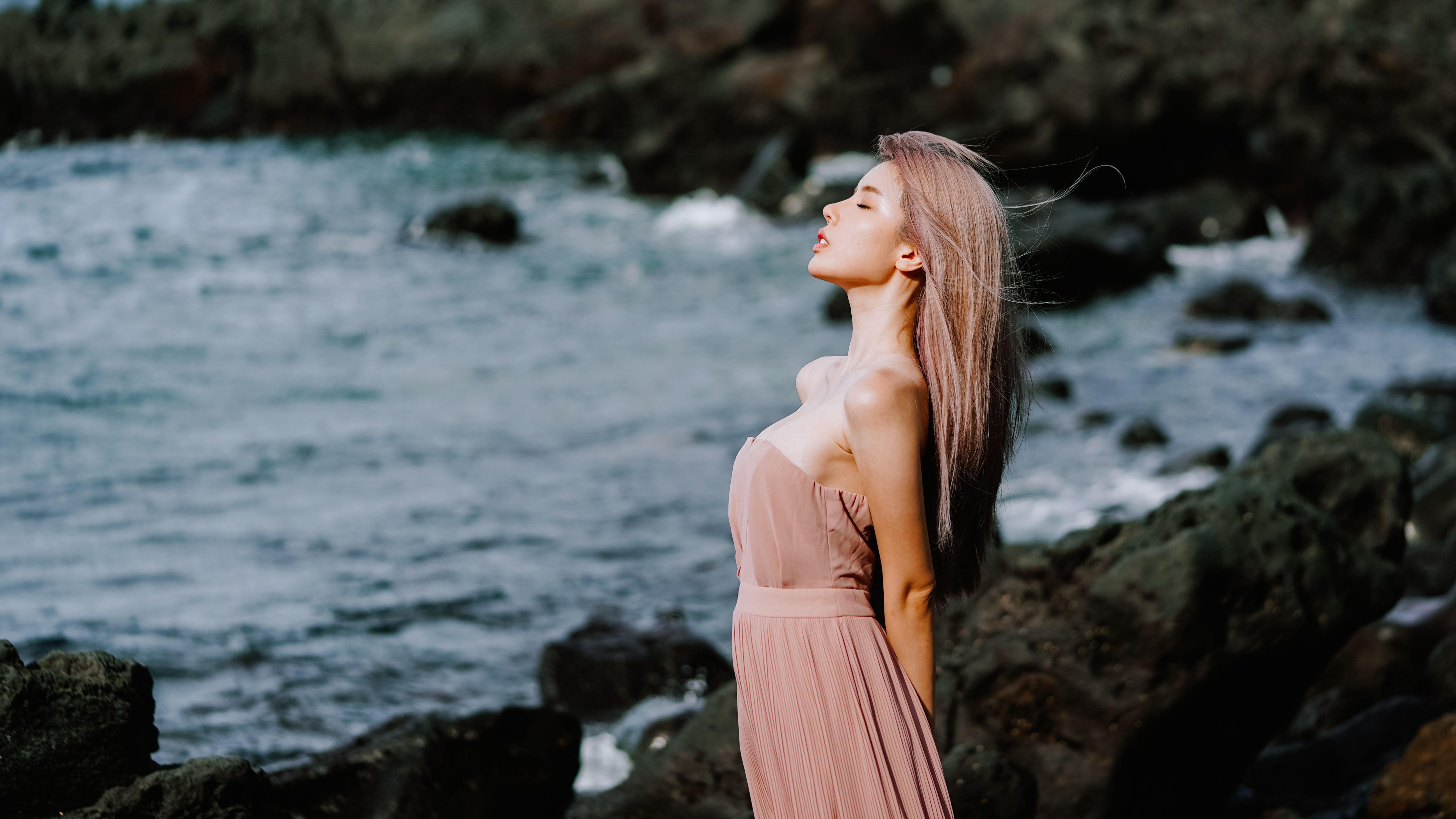 Blonde Model in Blue Dress Standing behind Bush · Free Stock Photo