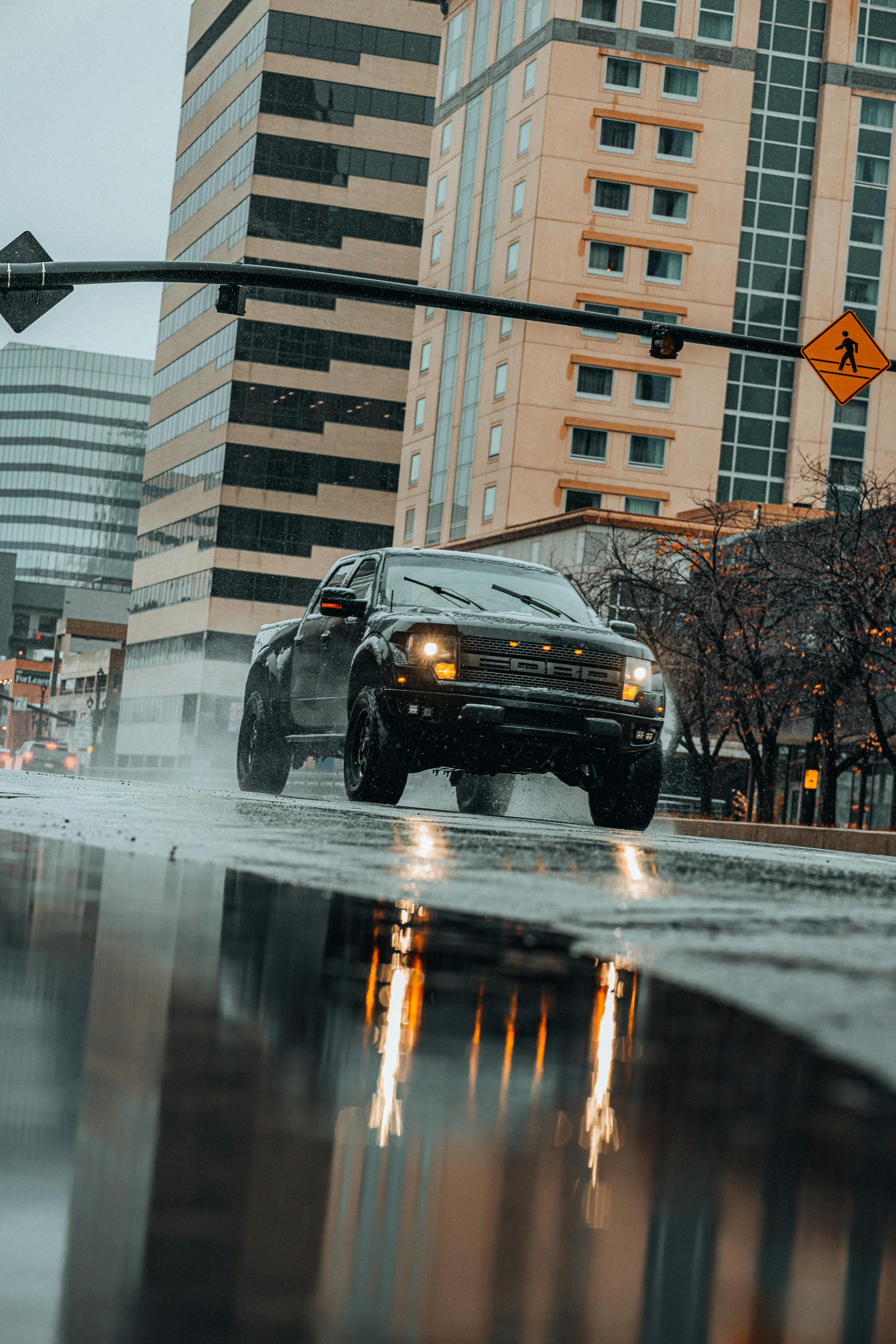 Ford Car Driving on Wet Street after Rain · Free Stock Photo