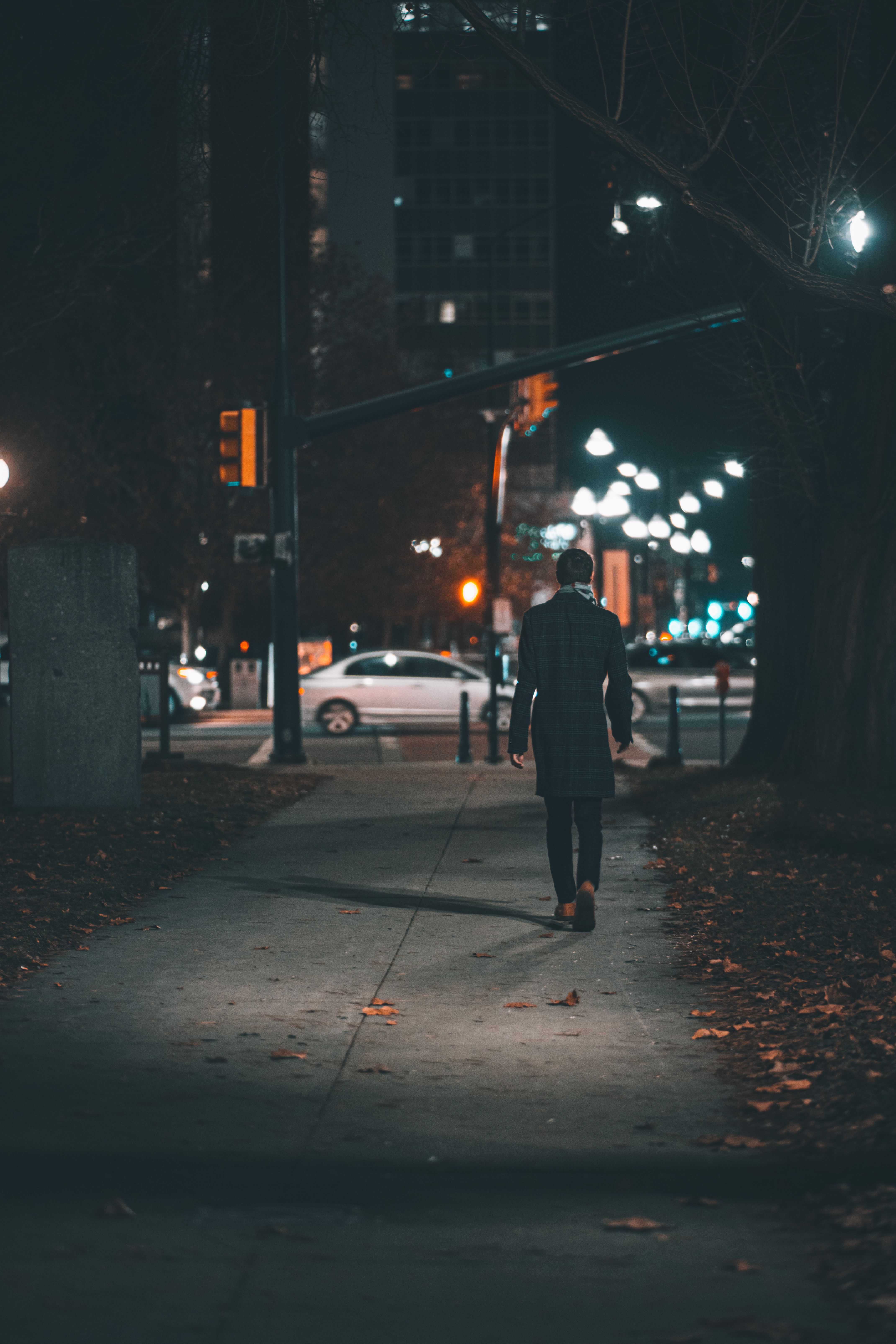 Person Walking on Sidewalk at Night · Free Stock Photo