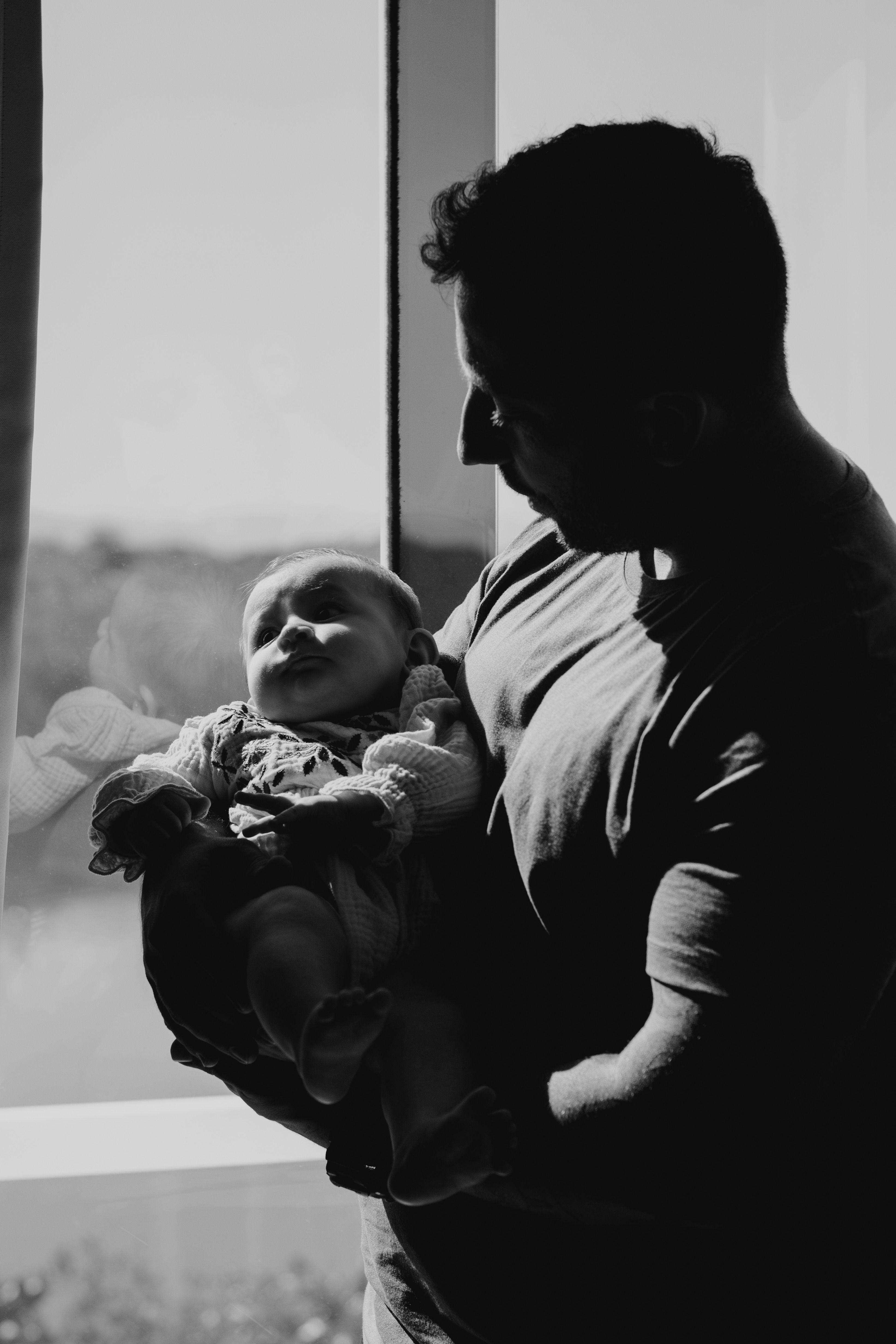 A Man Carrying a Baby on his Shoulder · Free Stock Photo
