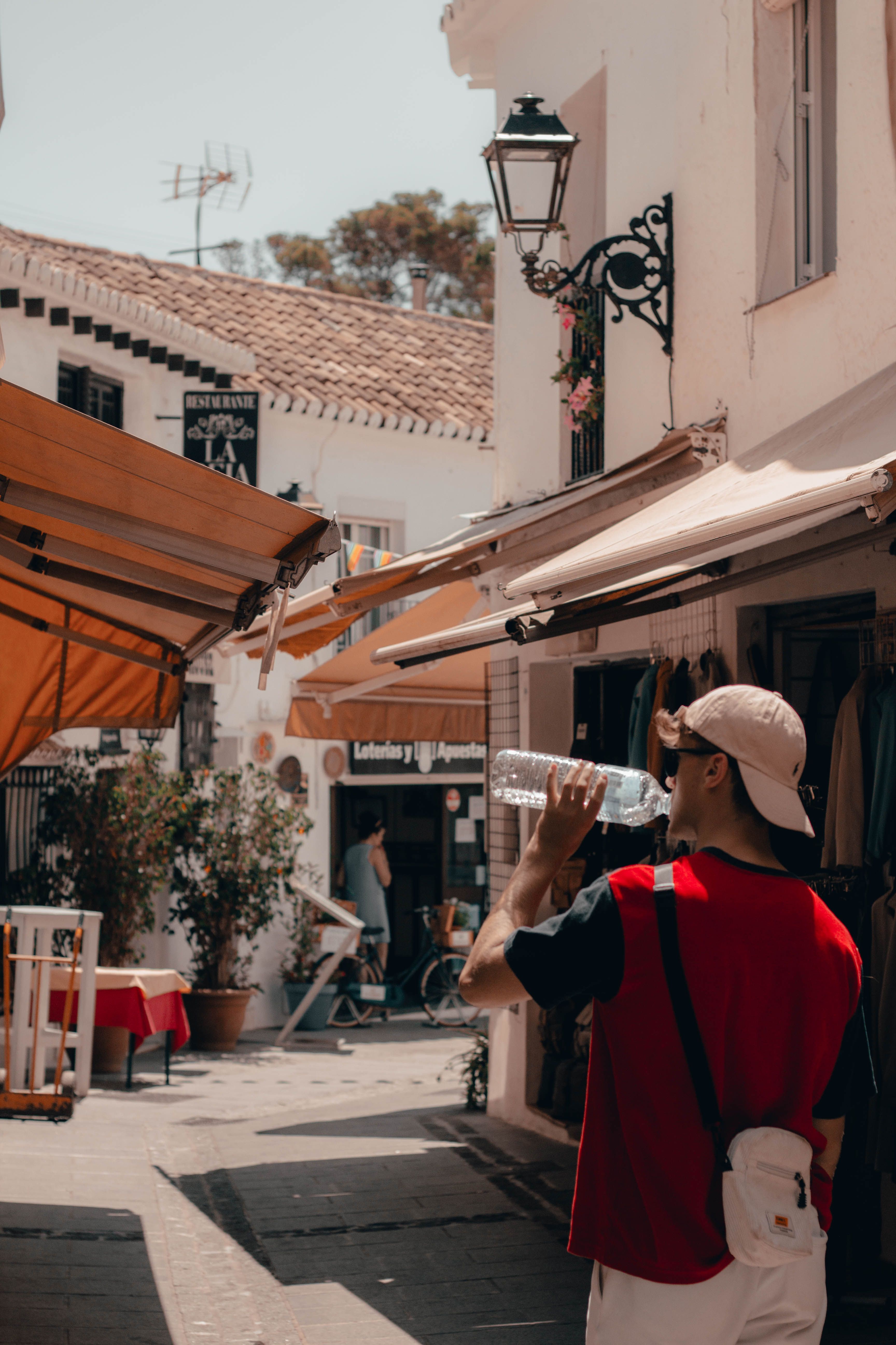 Man Drinking Water on Street in Town · Free Stock Photo