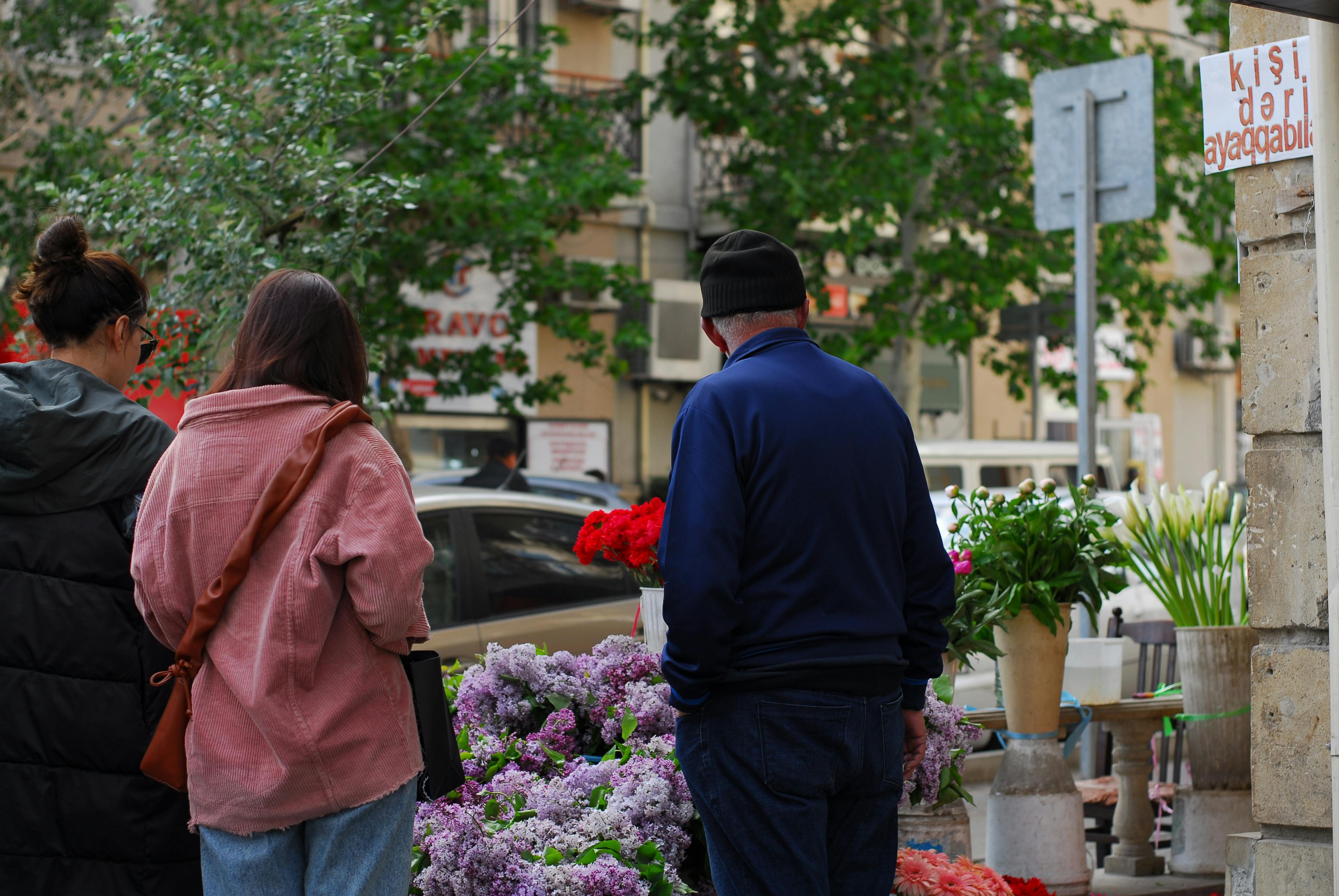 Man Selling Flowers on Sidewalk · Free Stock Photo