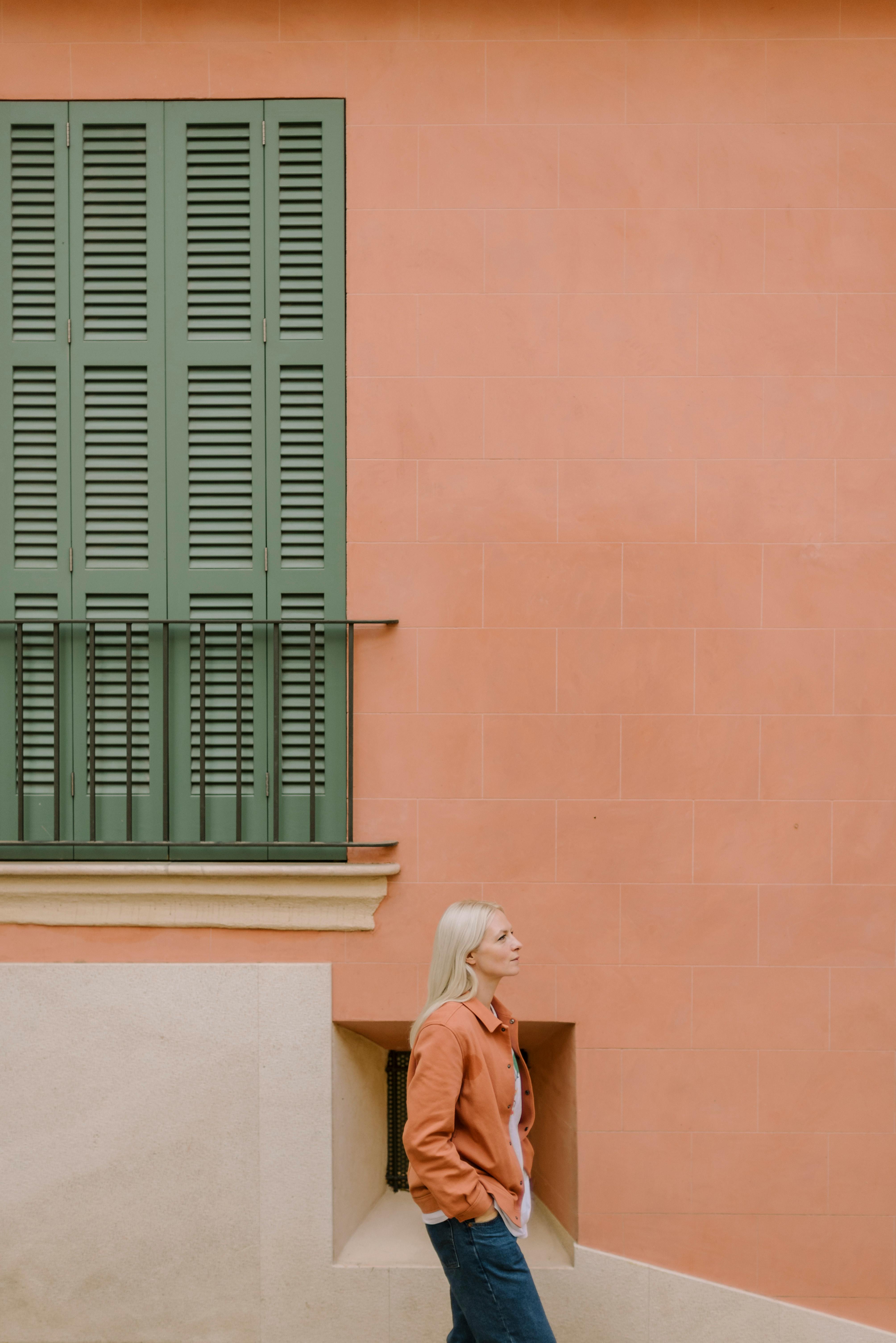 Woman near Building Wall · Free Stock Photo