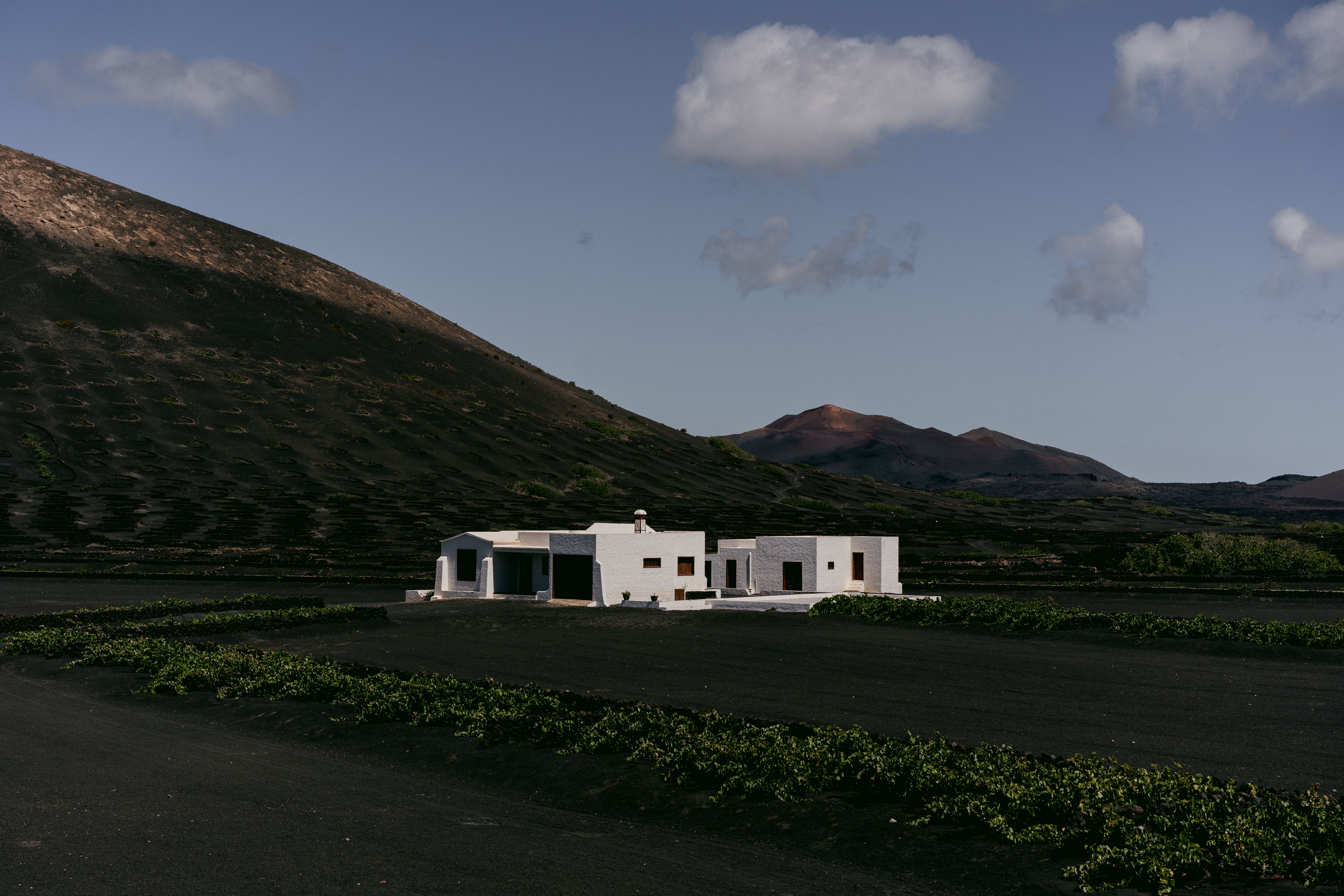 White Minimalist Building in Mountains Landscape · Free Stock Photo
