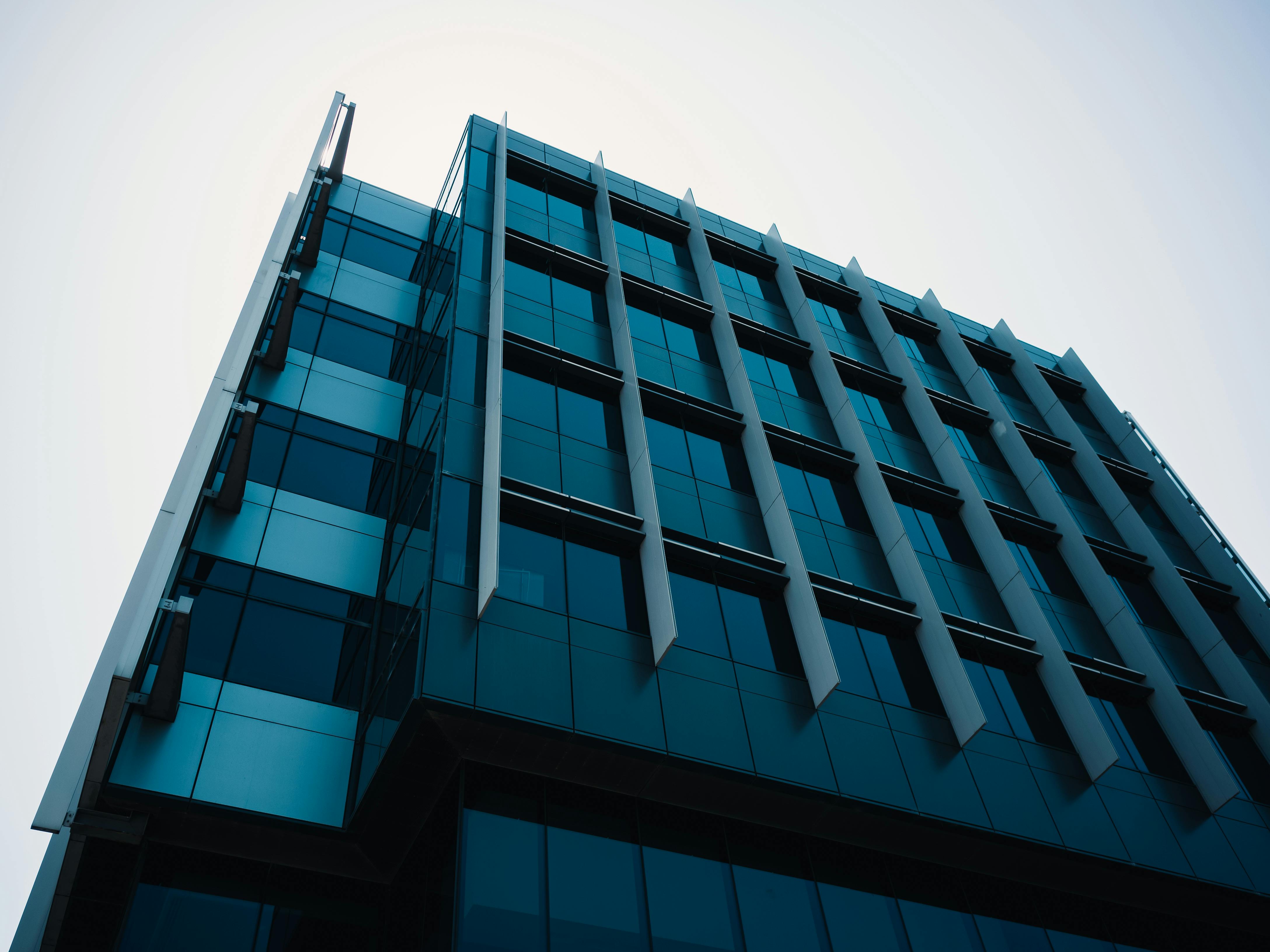 Low Angle Shot Of A Modern Building With Glass Exterior · Free Stock Photo