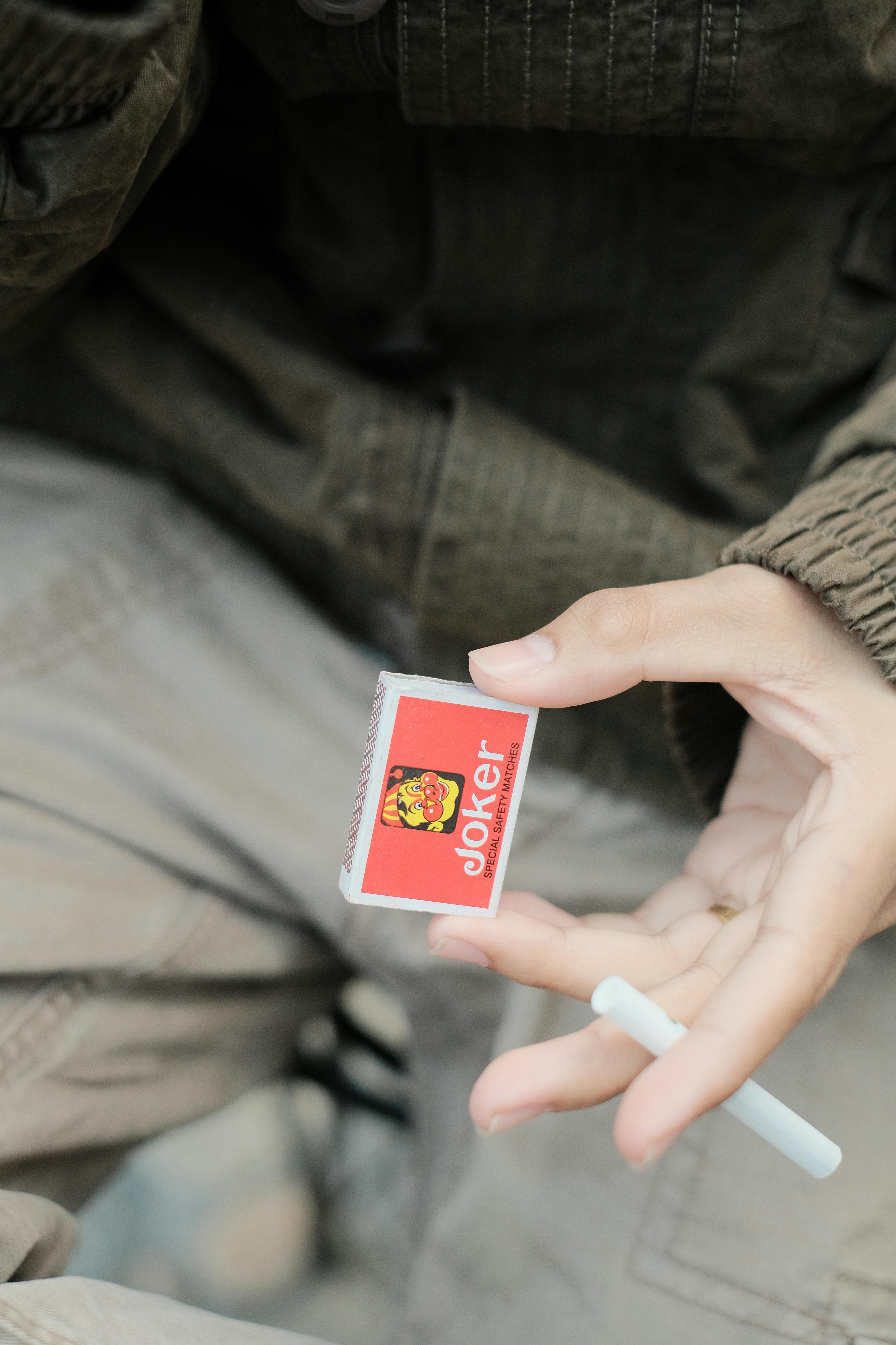 Close-up of Man Holding a Box of Matches and a Cigarette · Free Stock Photo