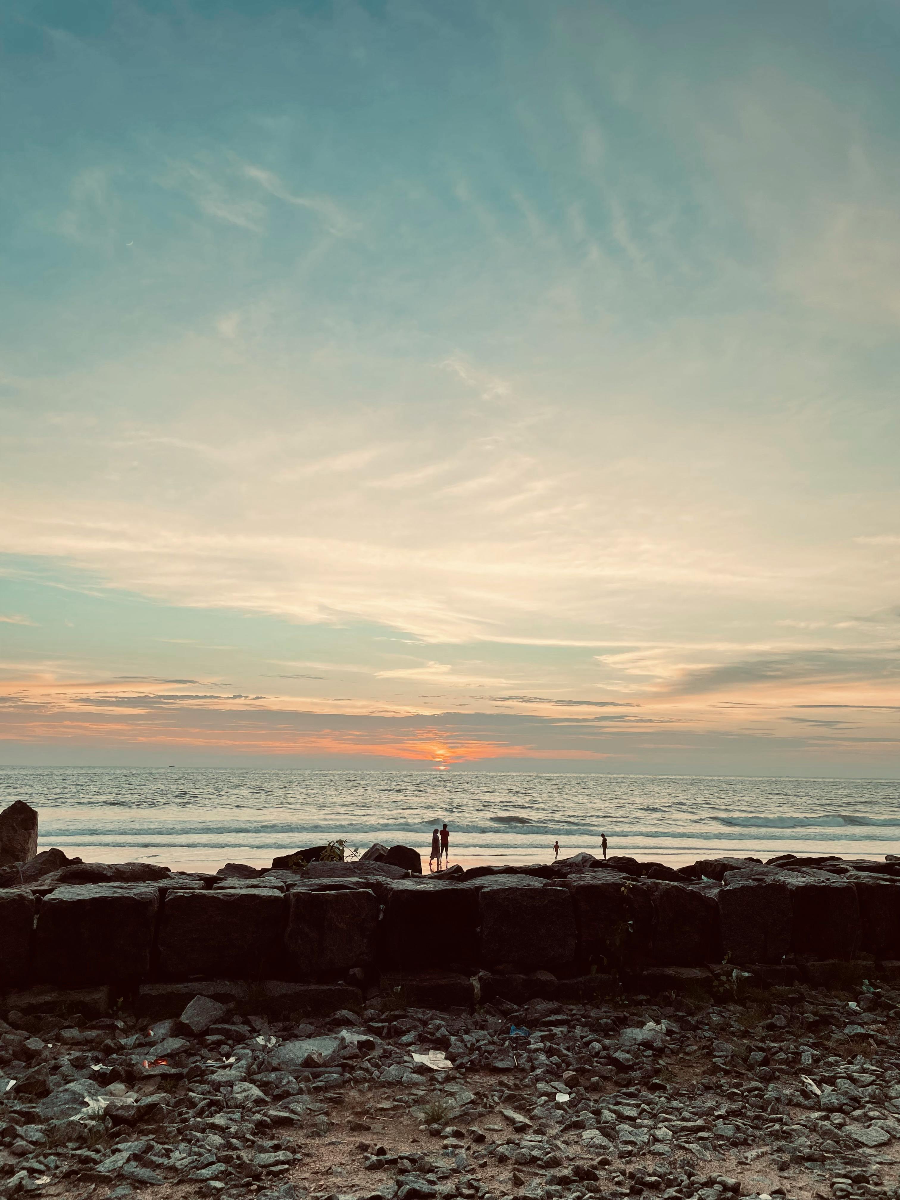Clouds over Beach with Stones at Sunset · Free Stock Photo