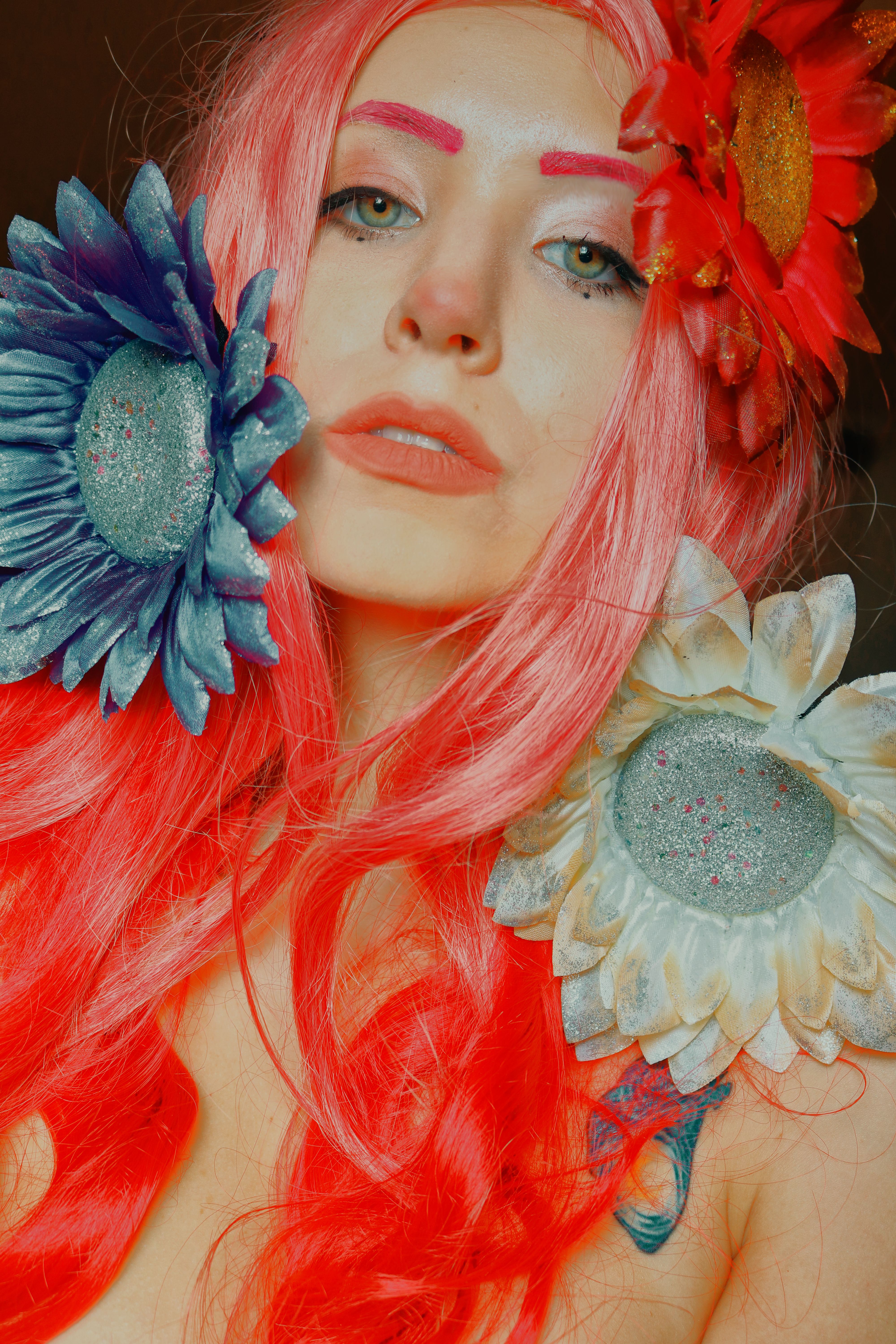 Photo of a Young Woman with Pink Hair Lying with Flowers around Her ...