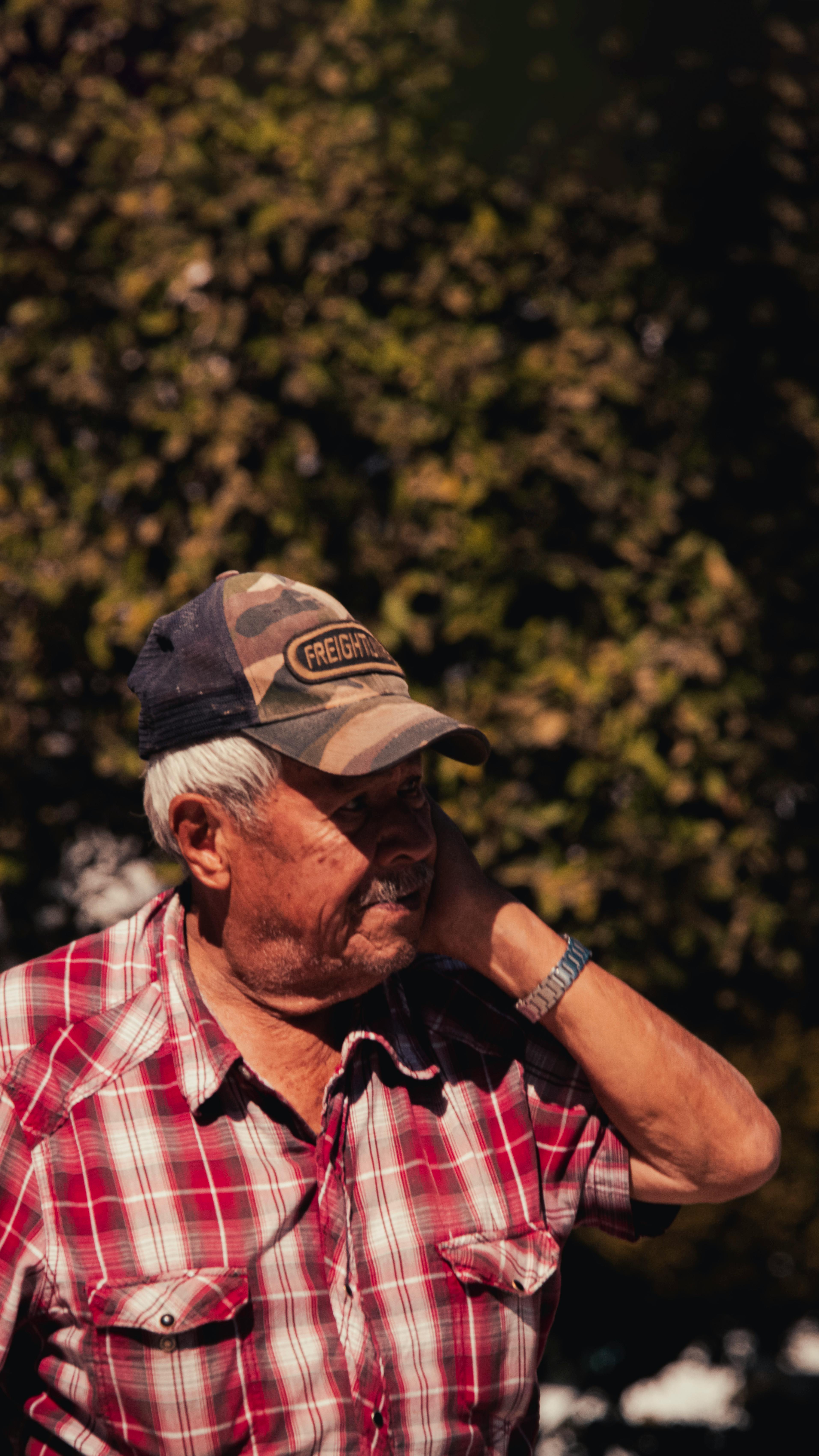 Elderly Man in Plaid Shirt Wearing Cap · Free Stock Photo