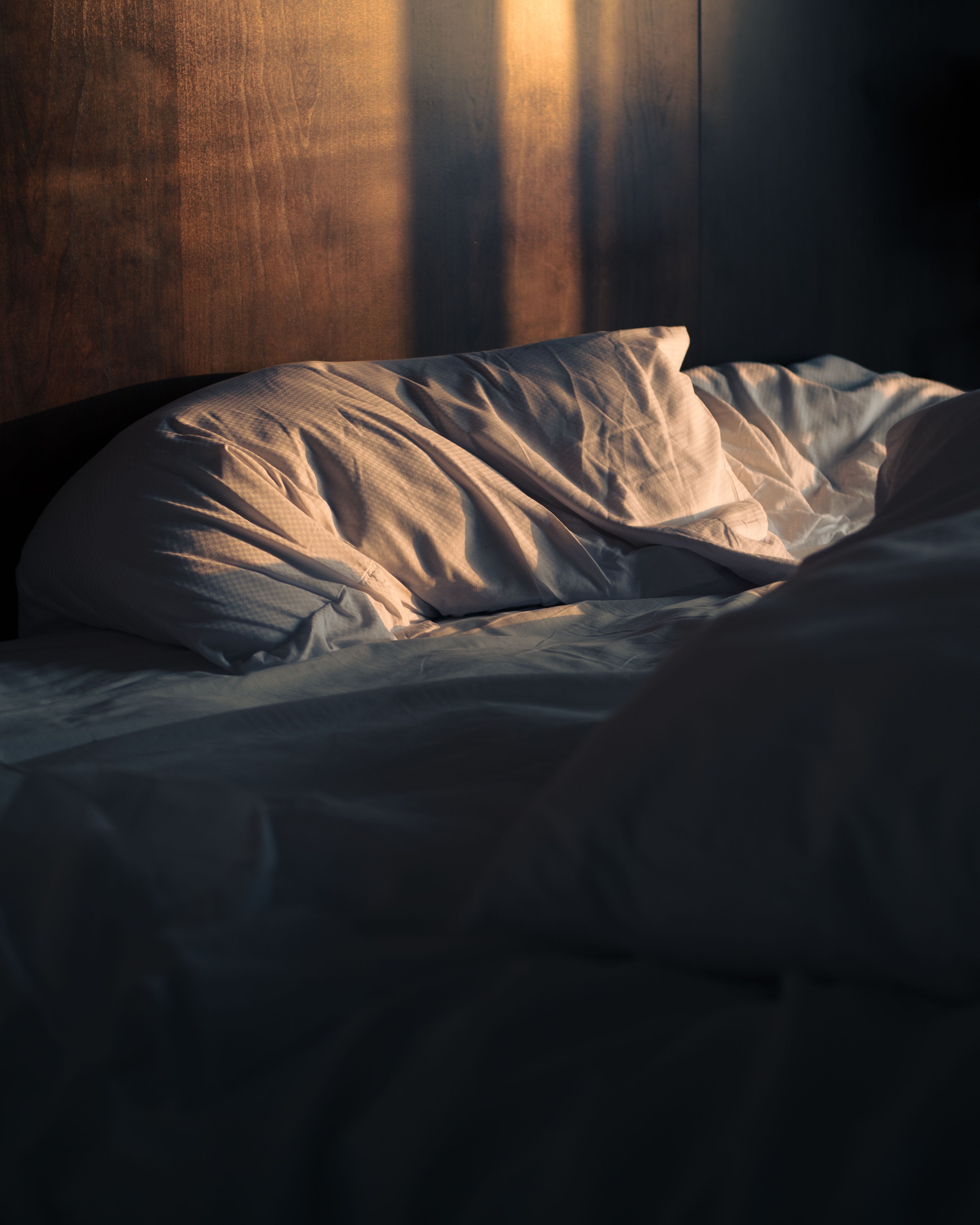 Sun Shining on a Bed with White Bed Sheets · Free Stock Photo