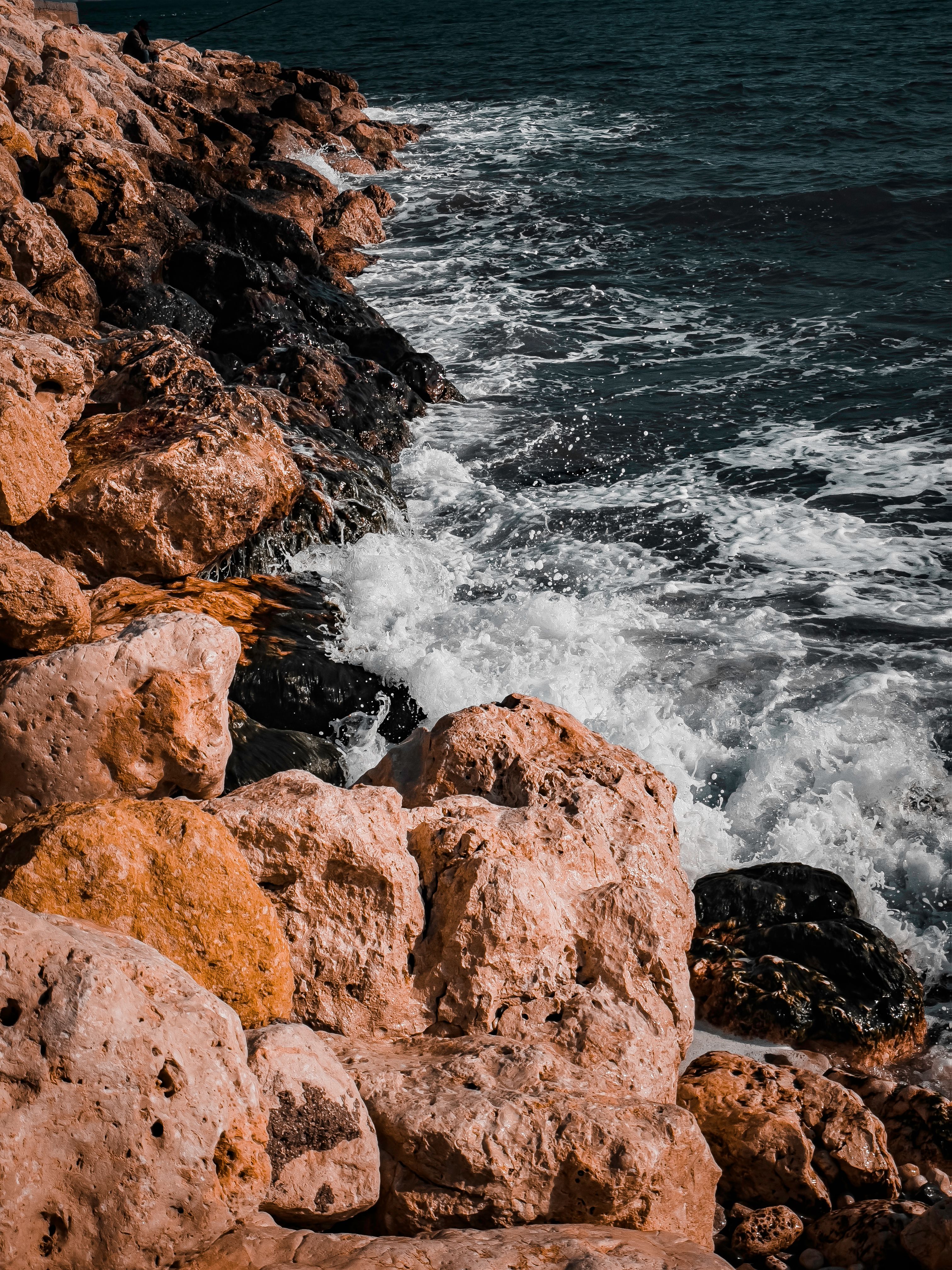 Beautiful Ocean with Rocks Under the Blue Sky · Free Stock Photo
