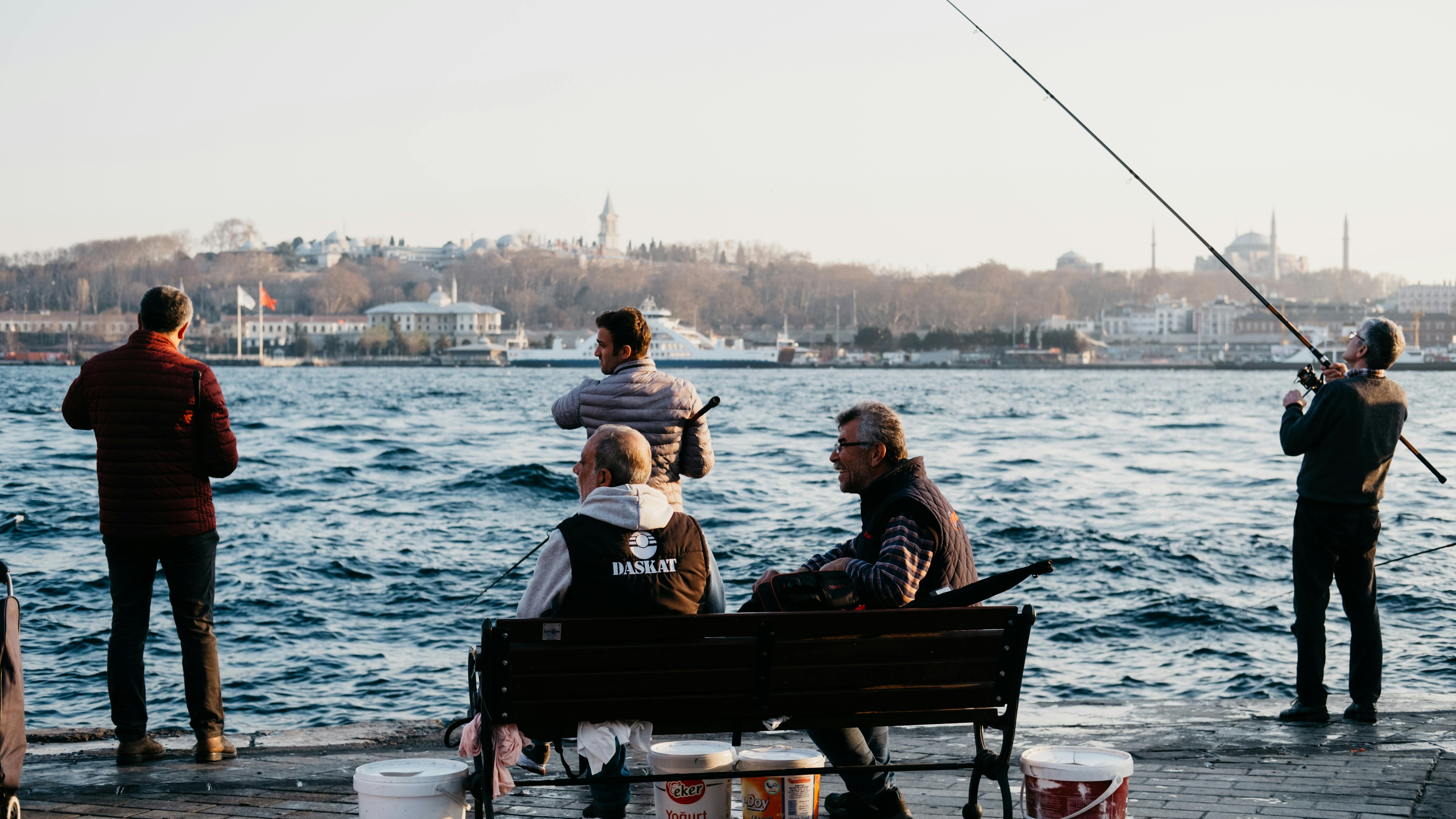 Anglers Fishing on the Waterfront · Free Stock Photo