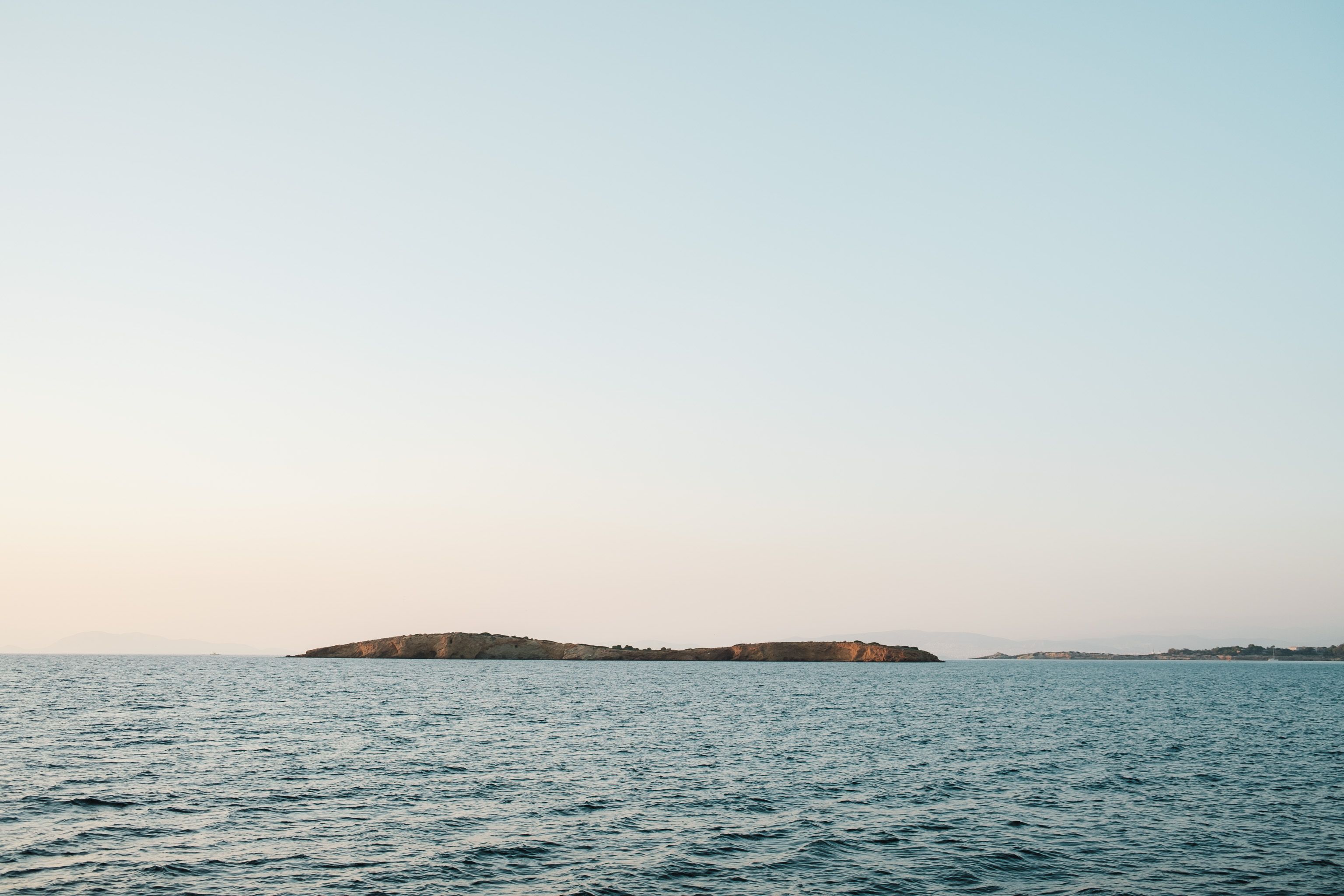 Calm Sea with Island on Coast · Free Stock Photo