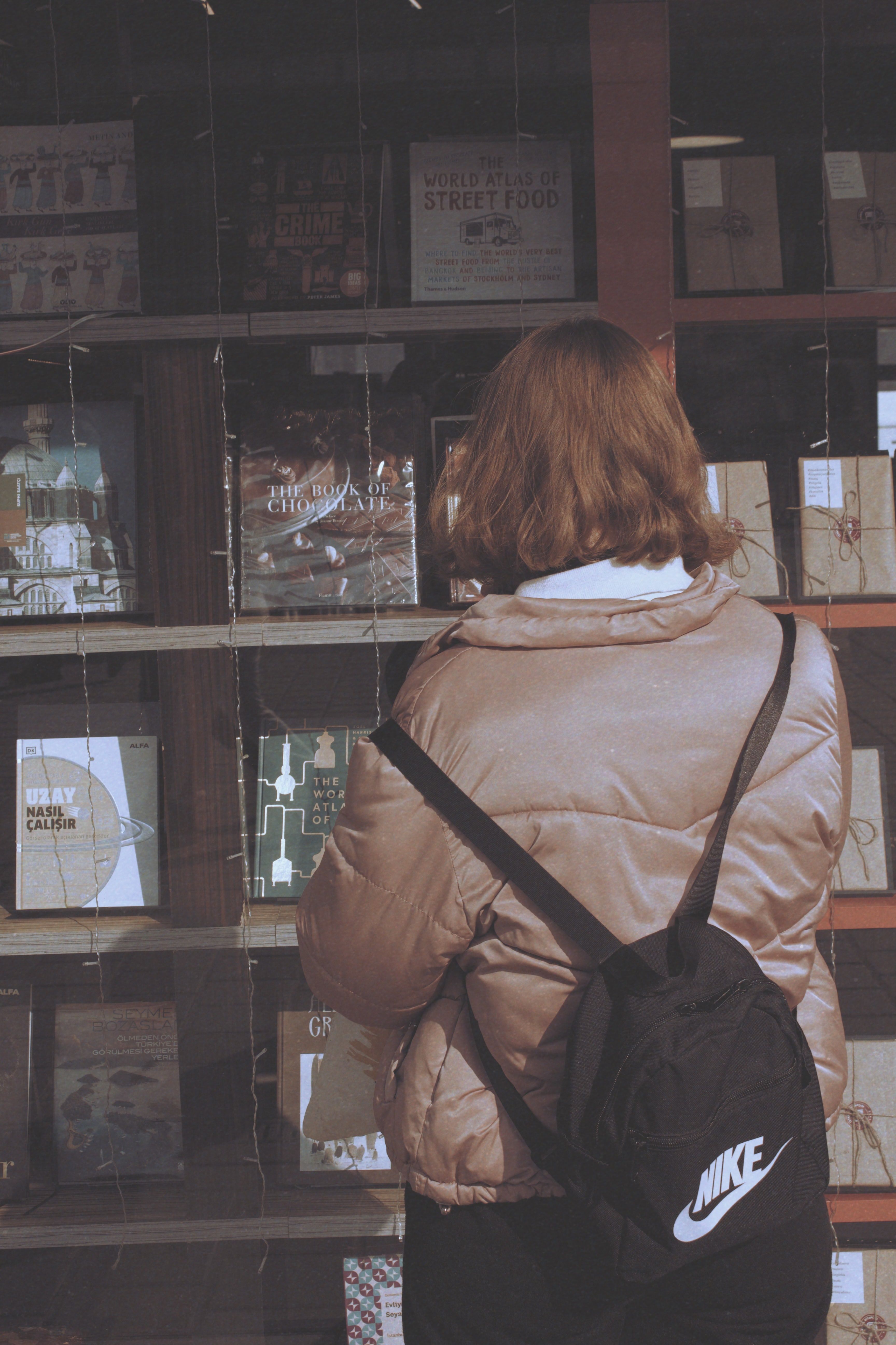 Man Looking Through the Window at the Books on the Display of a ...