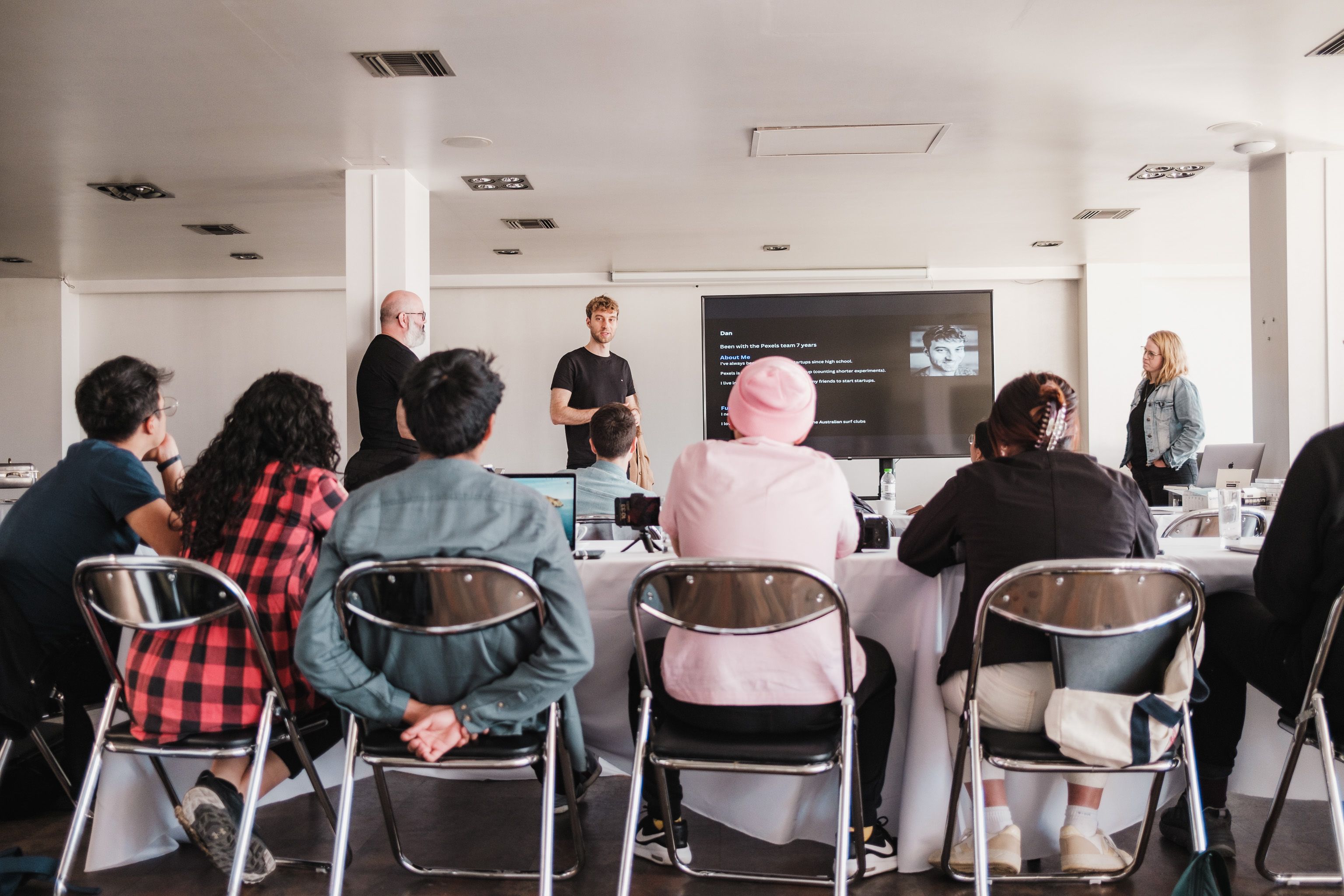 A group of people sitting at tables in a room · Free Stock Photo