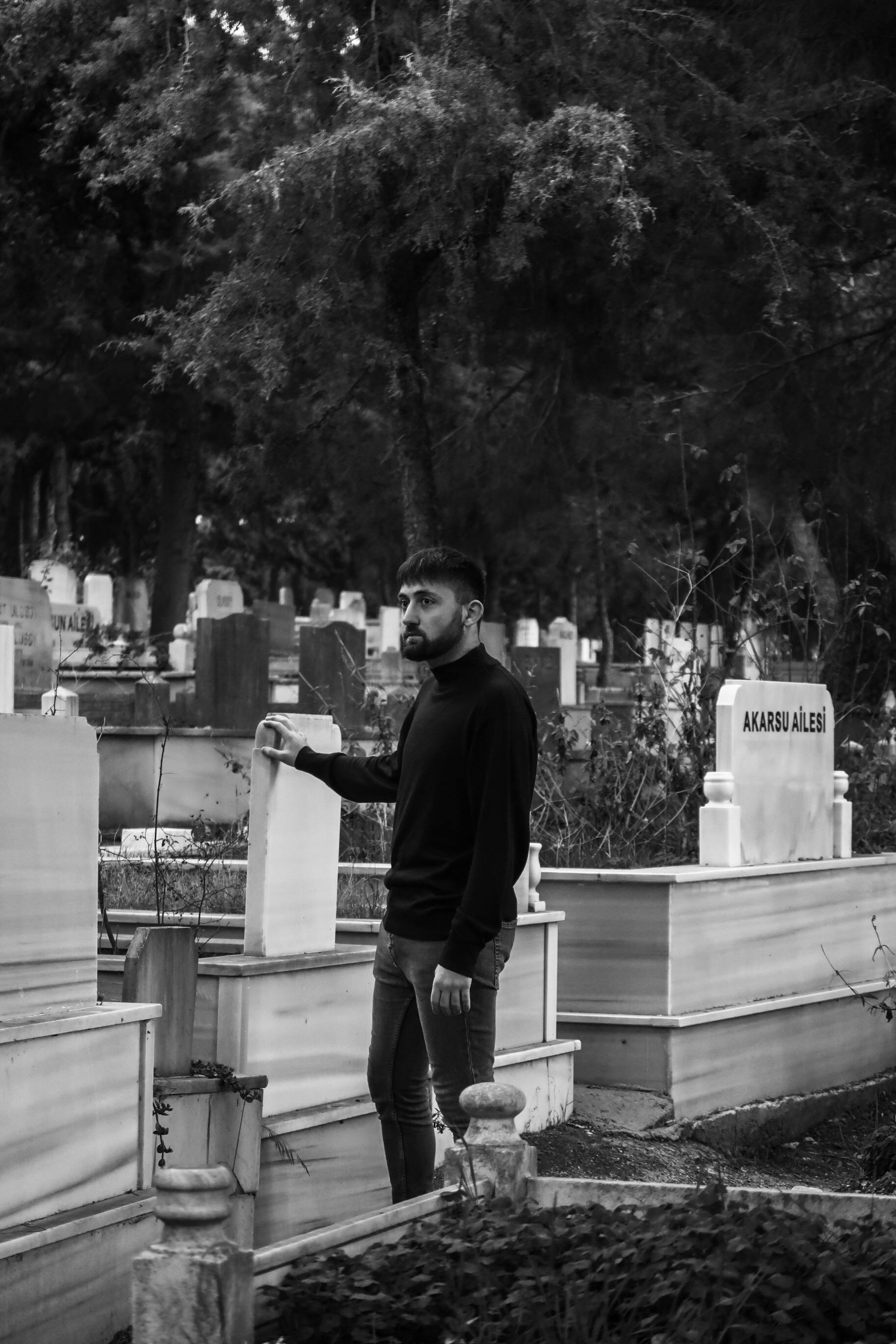 A Man Standing in a Graveyard · Free Stock Photo