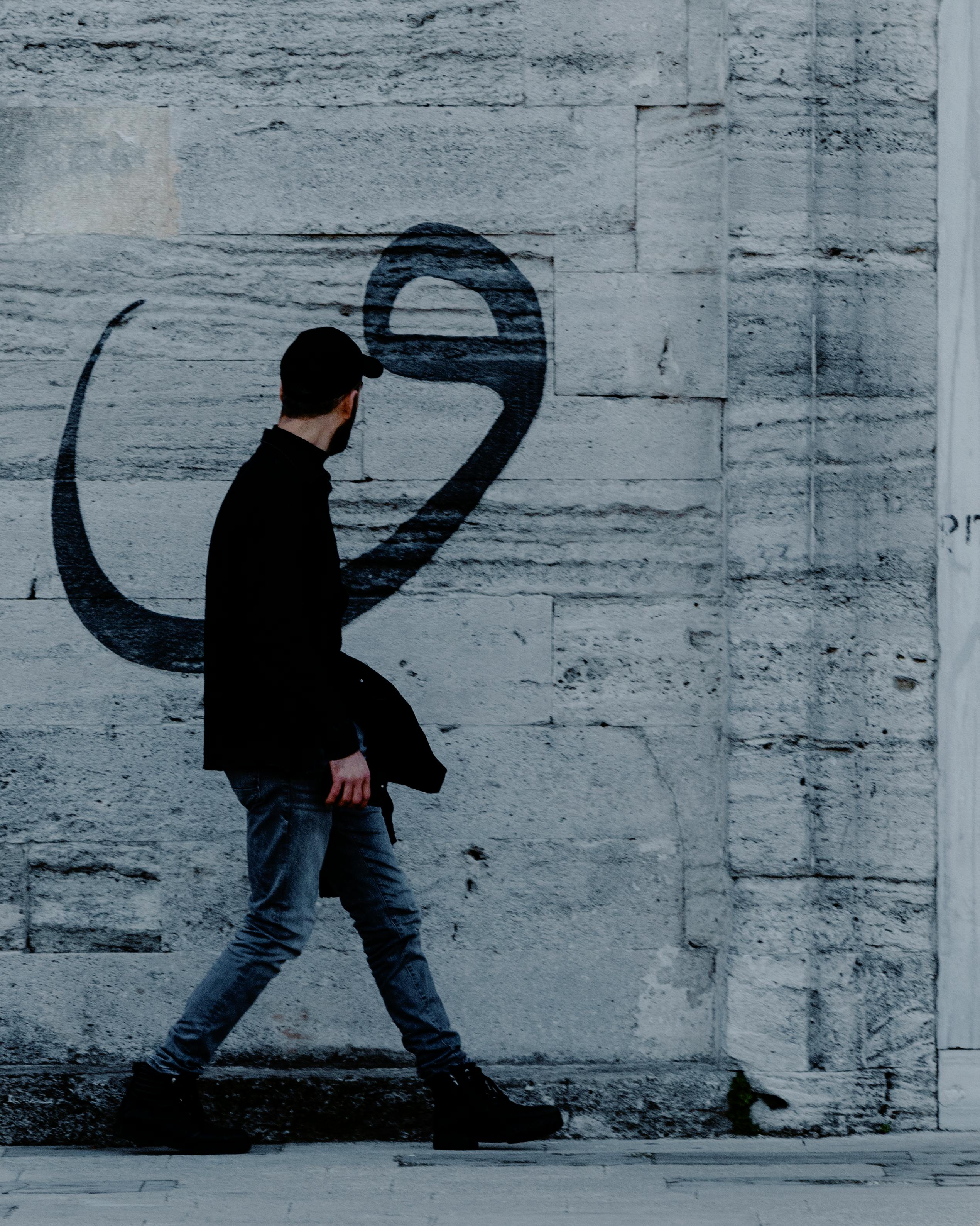 Man Walking near Writing on Wall · Free Stock Photo