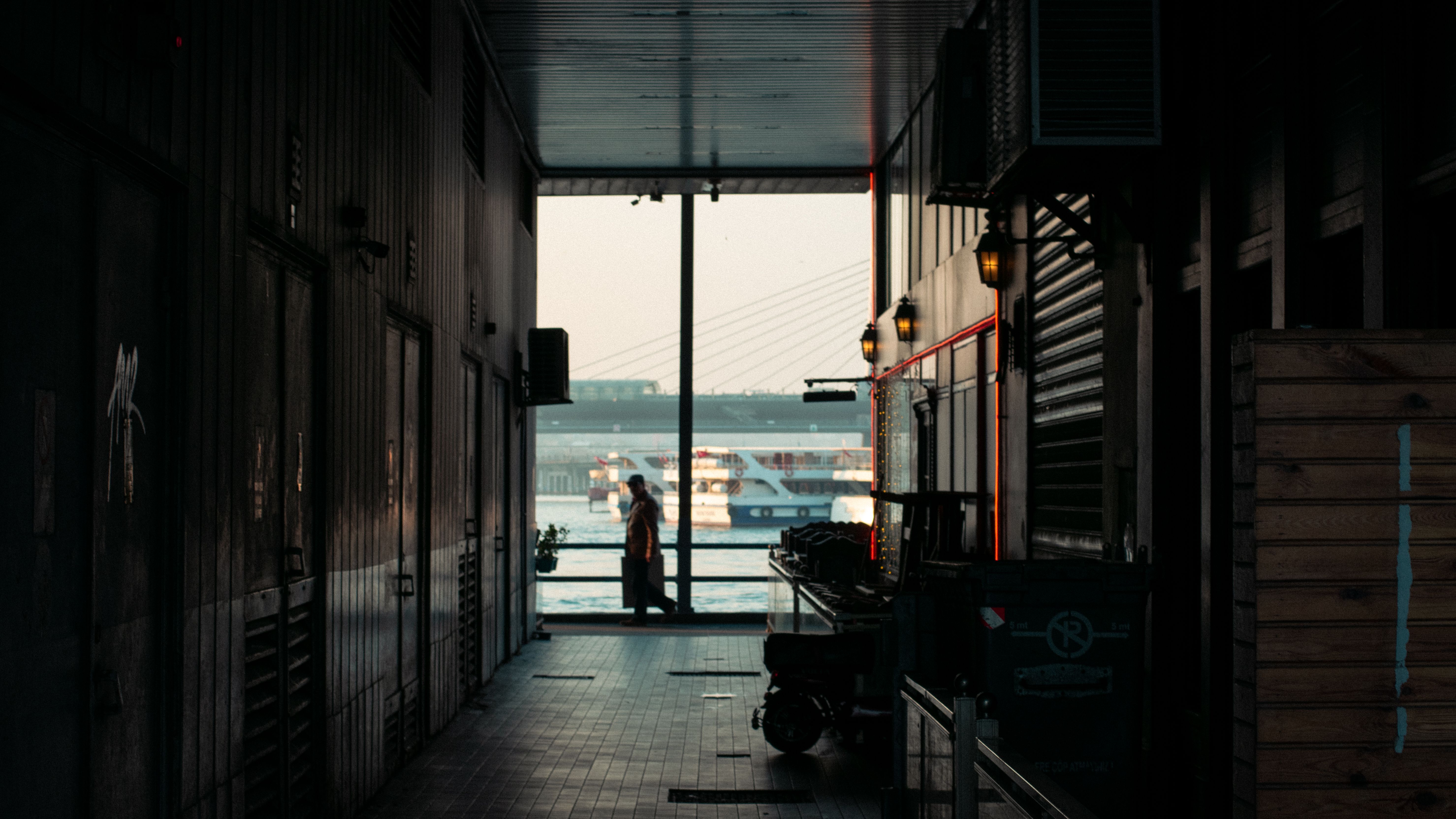 Man Walking in the Corridor with a View of Sea · Free Stock Photo