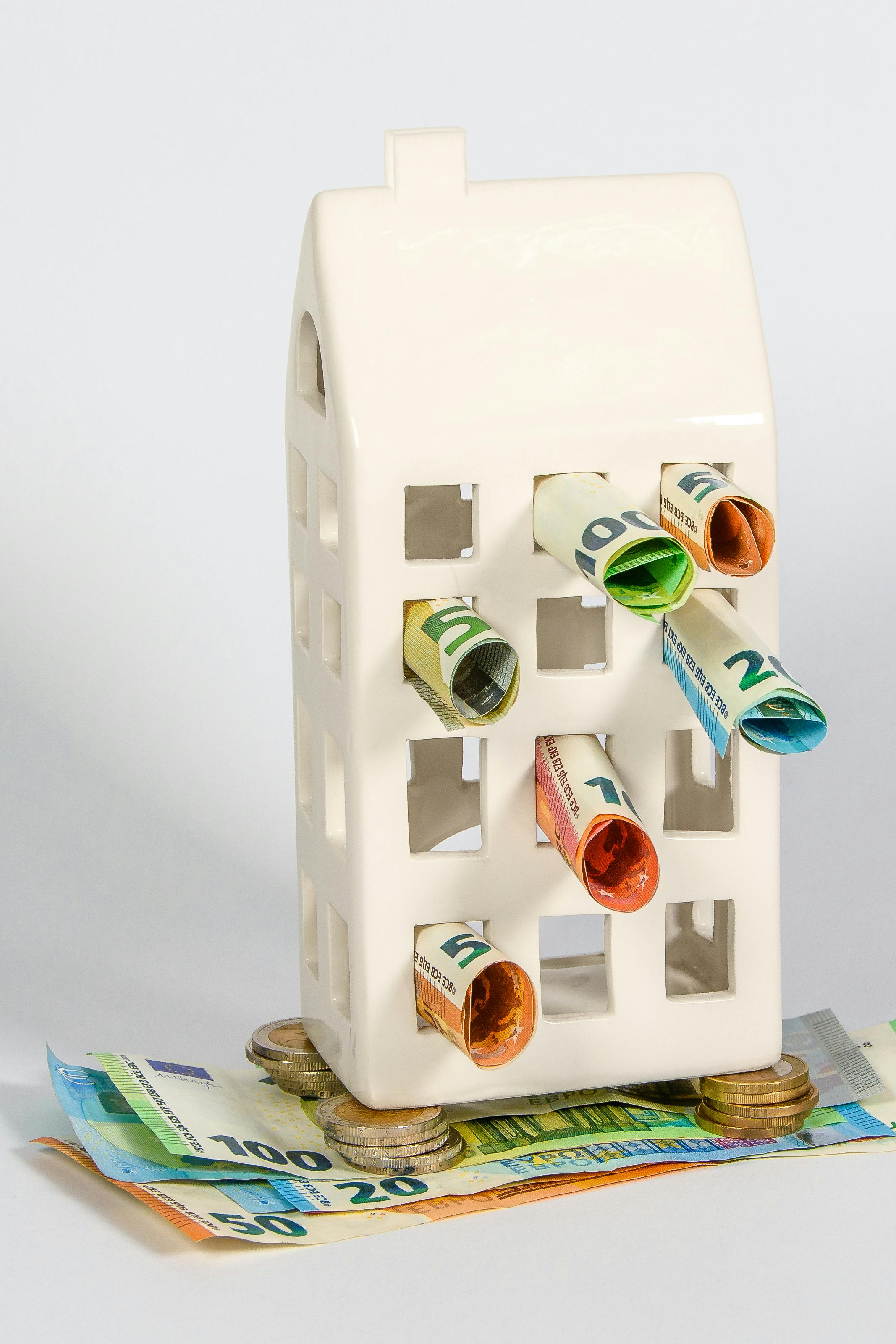 A house made of money with a stack of money on top · Free Stock Photo
