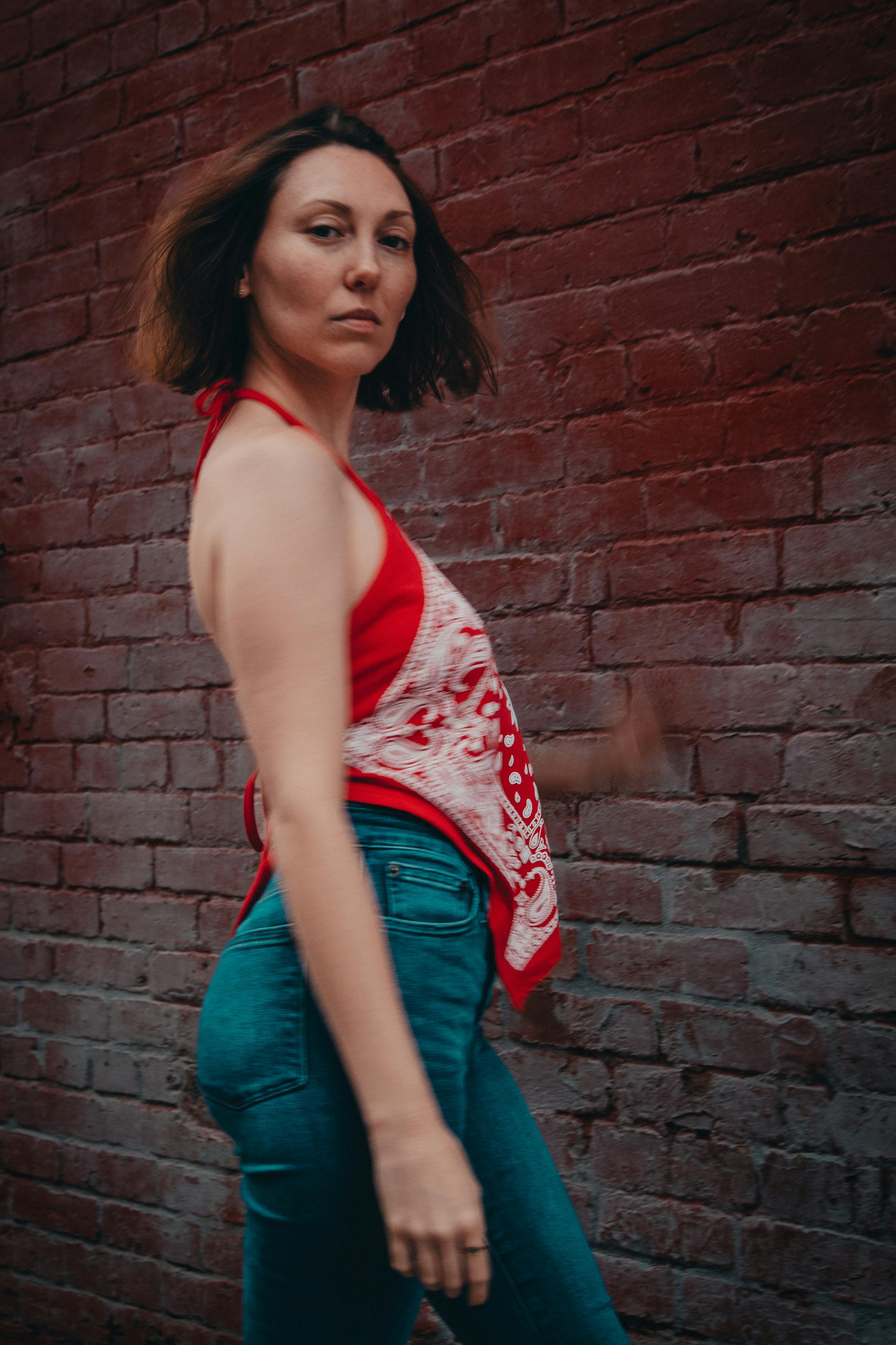 Woman in Blue Jeans and Red Top · Free Stock Photo