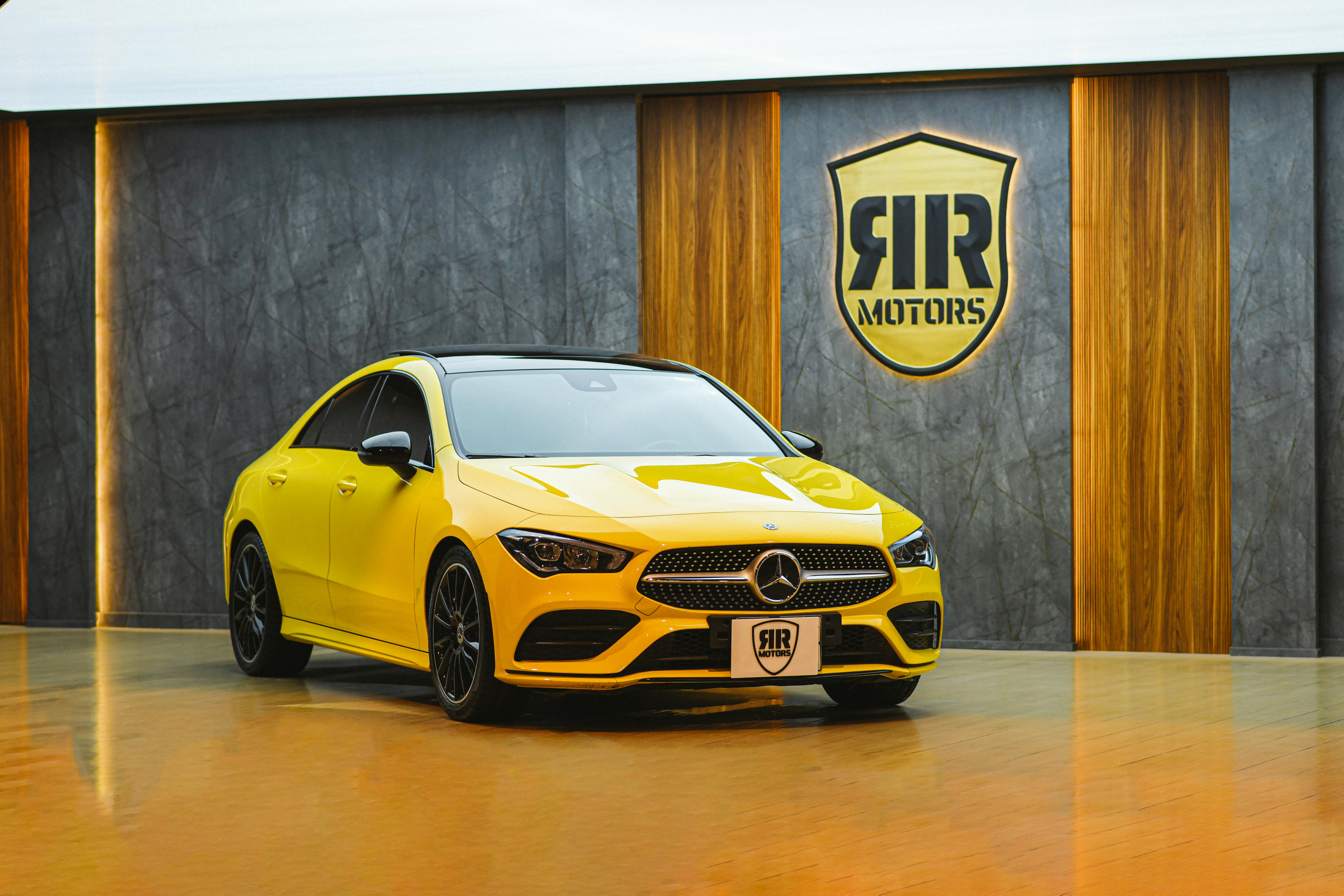 Yellow Mercedes Benz in a Showroom · Free Stock Photo